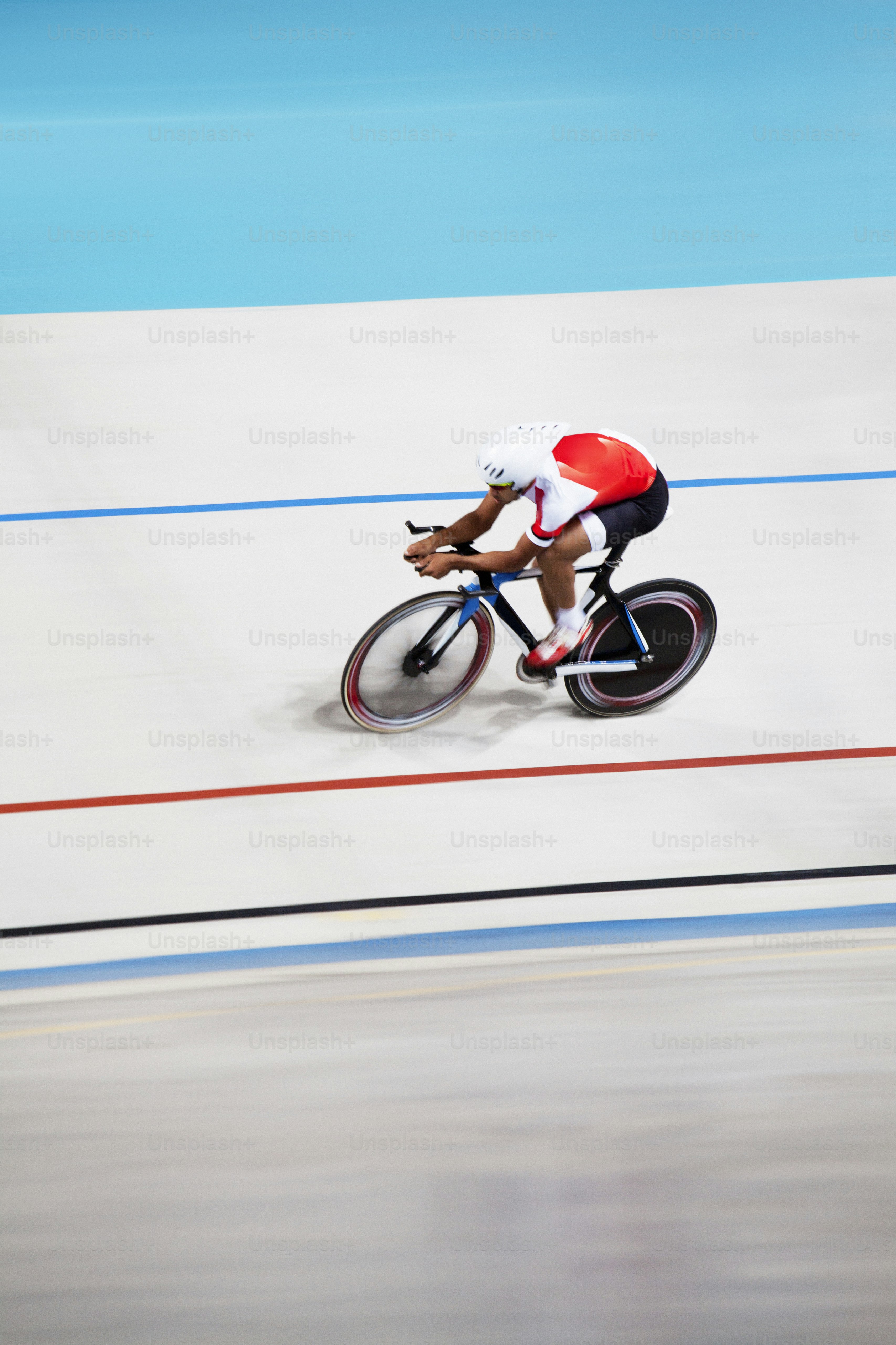 A man riding a bike down a track photo – Competition Image on Unsplash