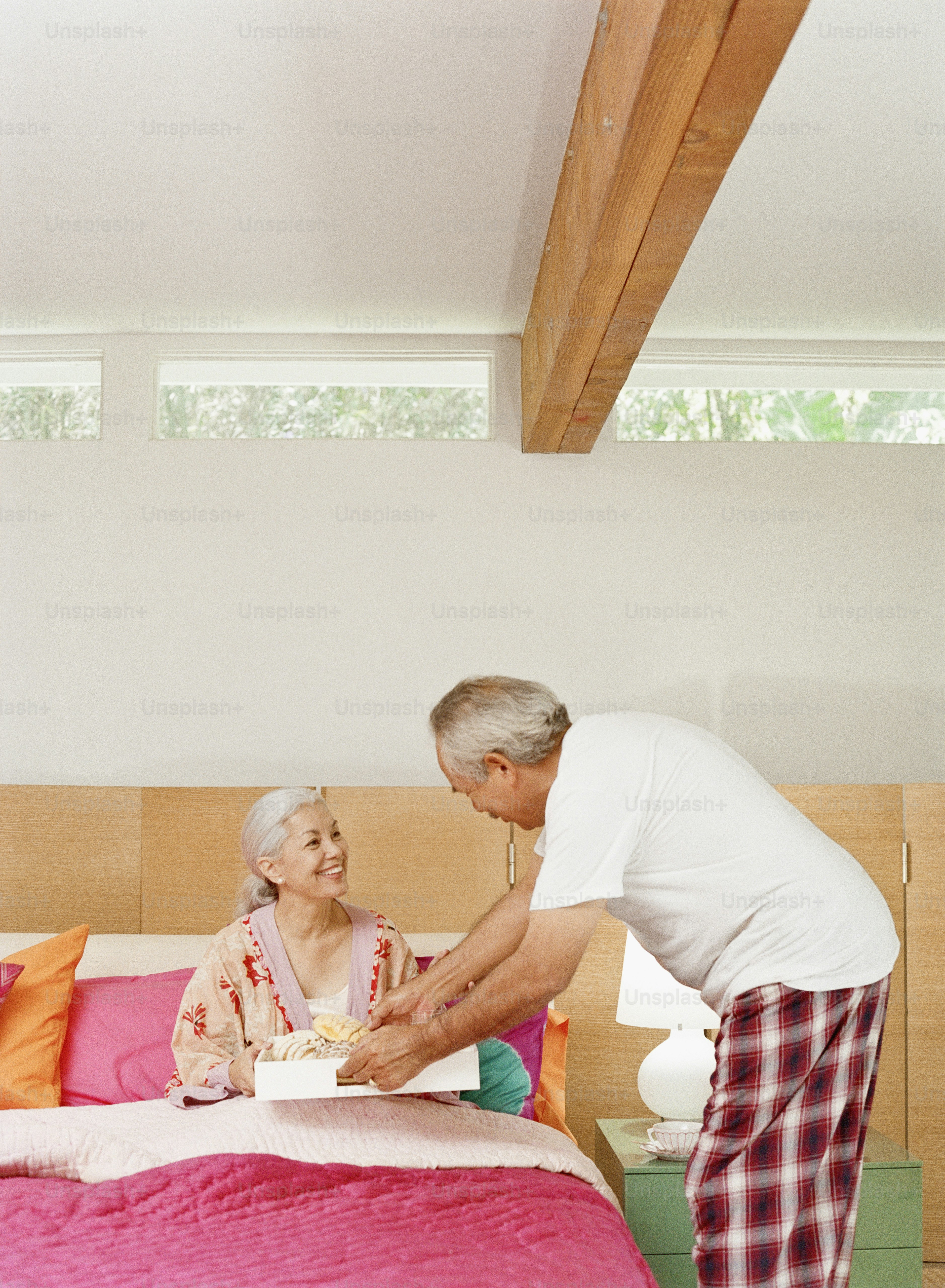A man and a woman standing over a bed photo – Indoors Image on Unsplash
