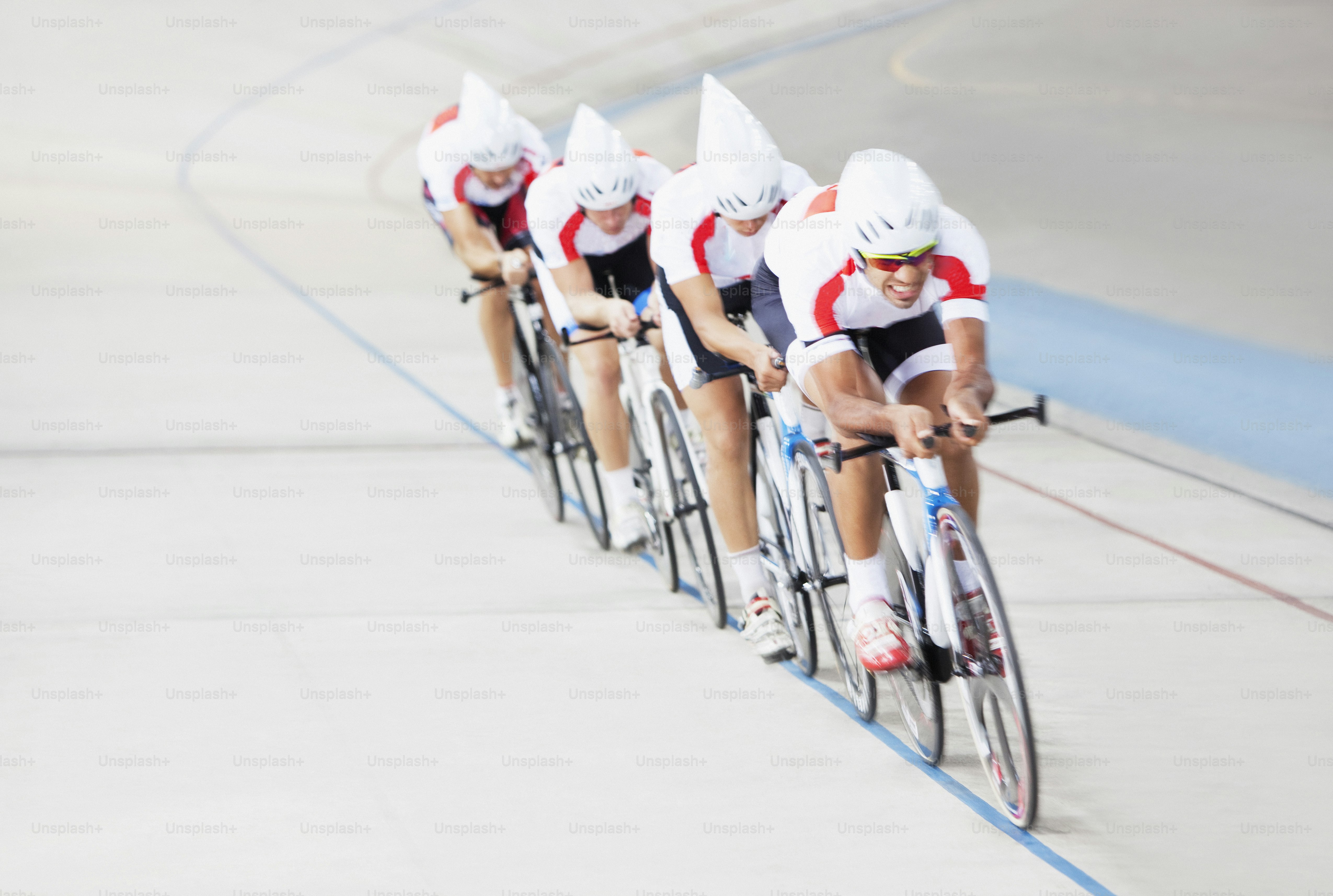 A group of men riding bikes down a track photo – Black men Image on ...