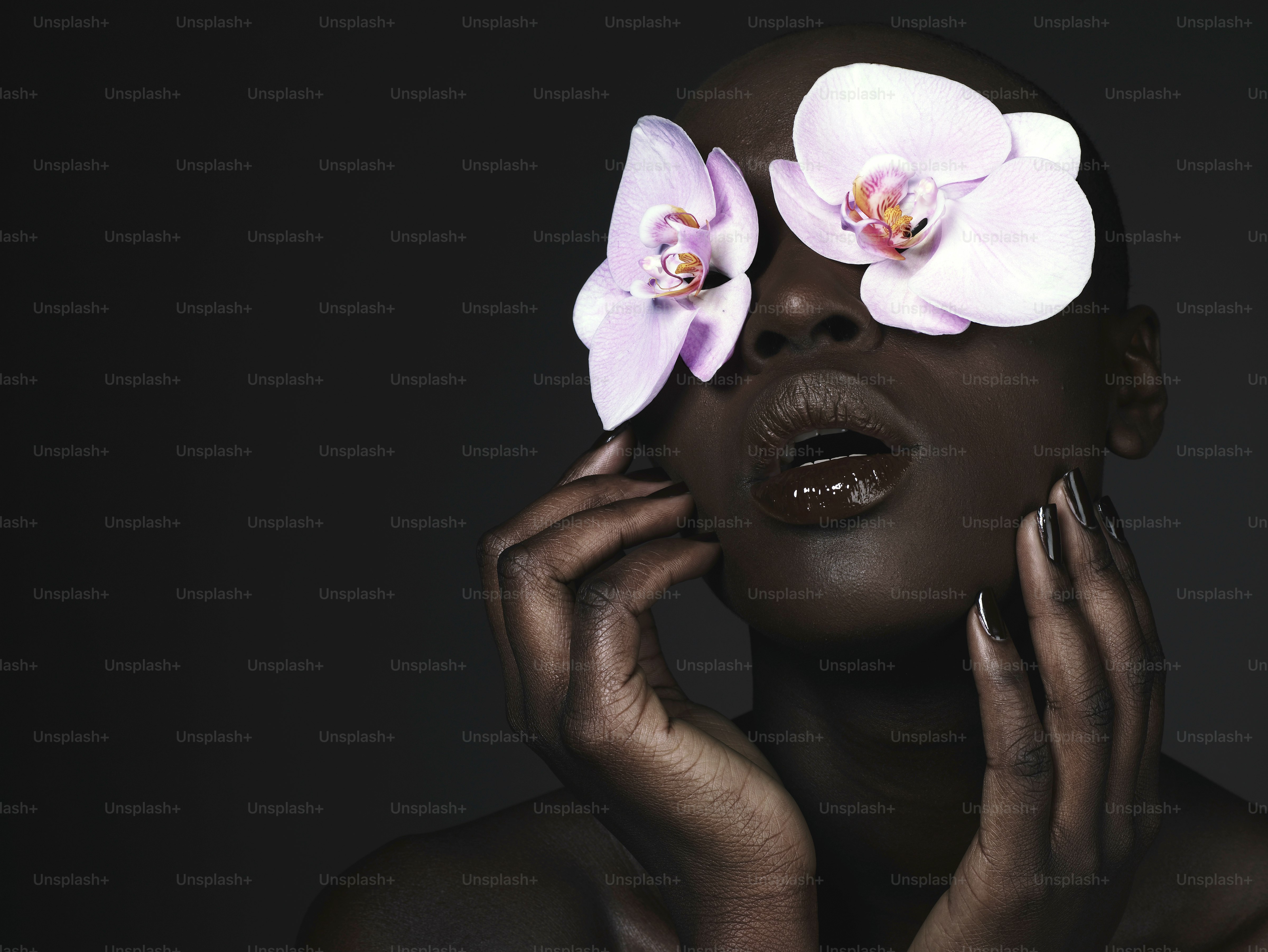 A woman with two orchids on her face photo – Flower Image on Unsplash