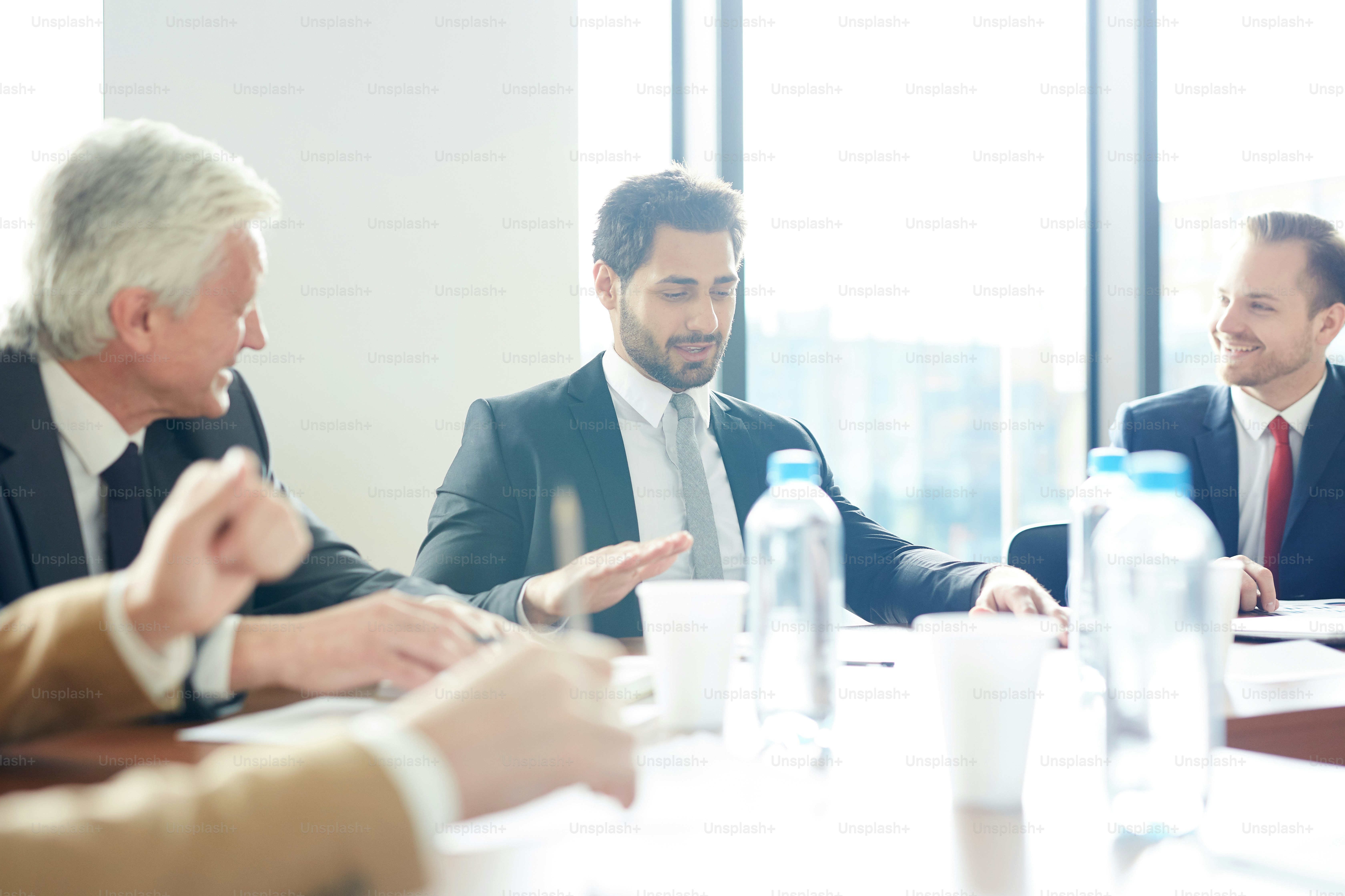 Positive confident executives thinking of business issues and ...