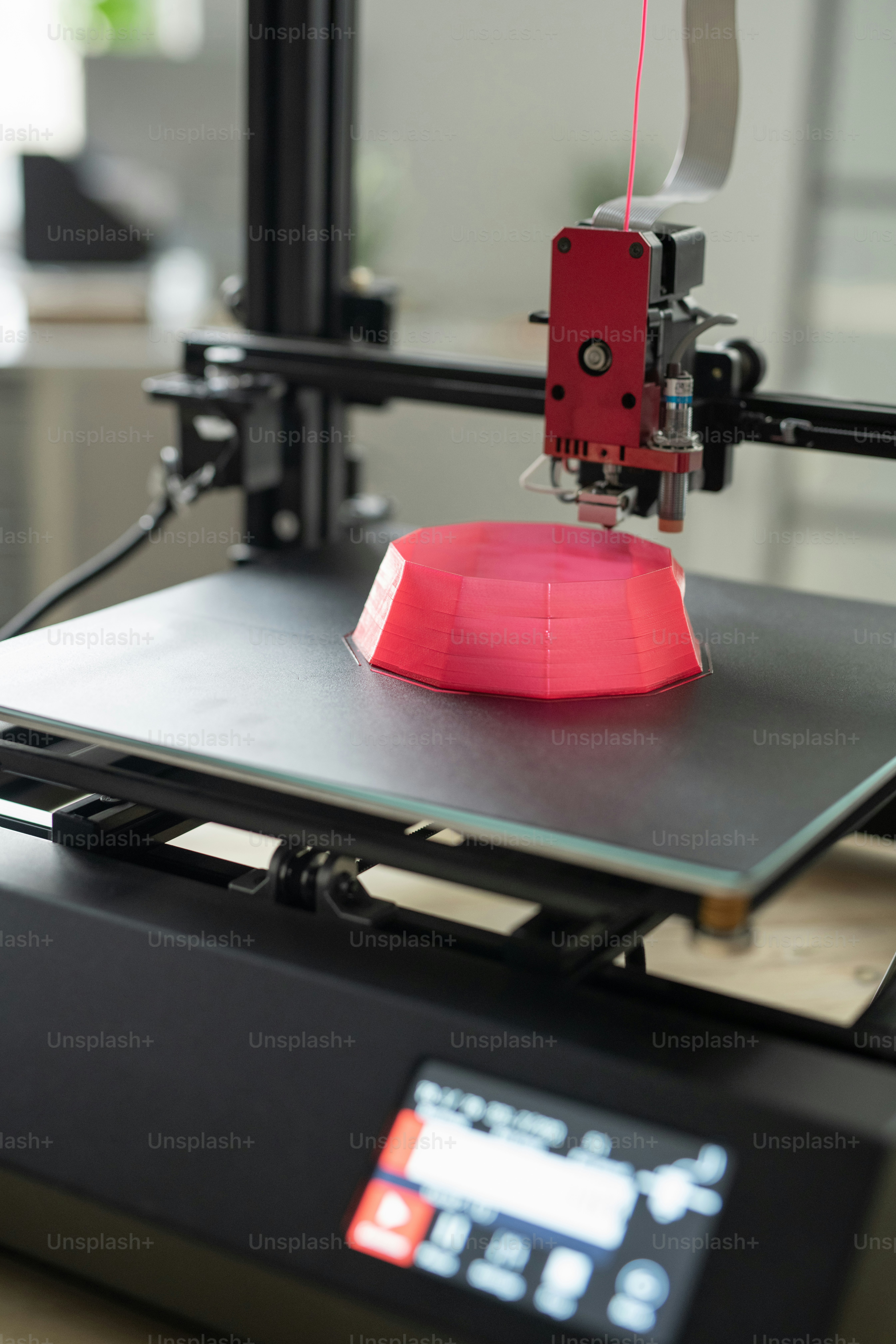 Printhead of 3d printer over part of pink round object on working ...