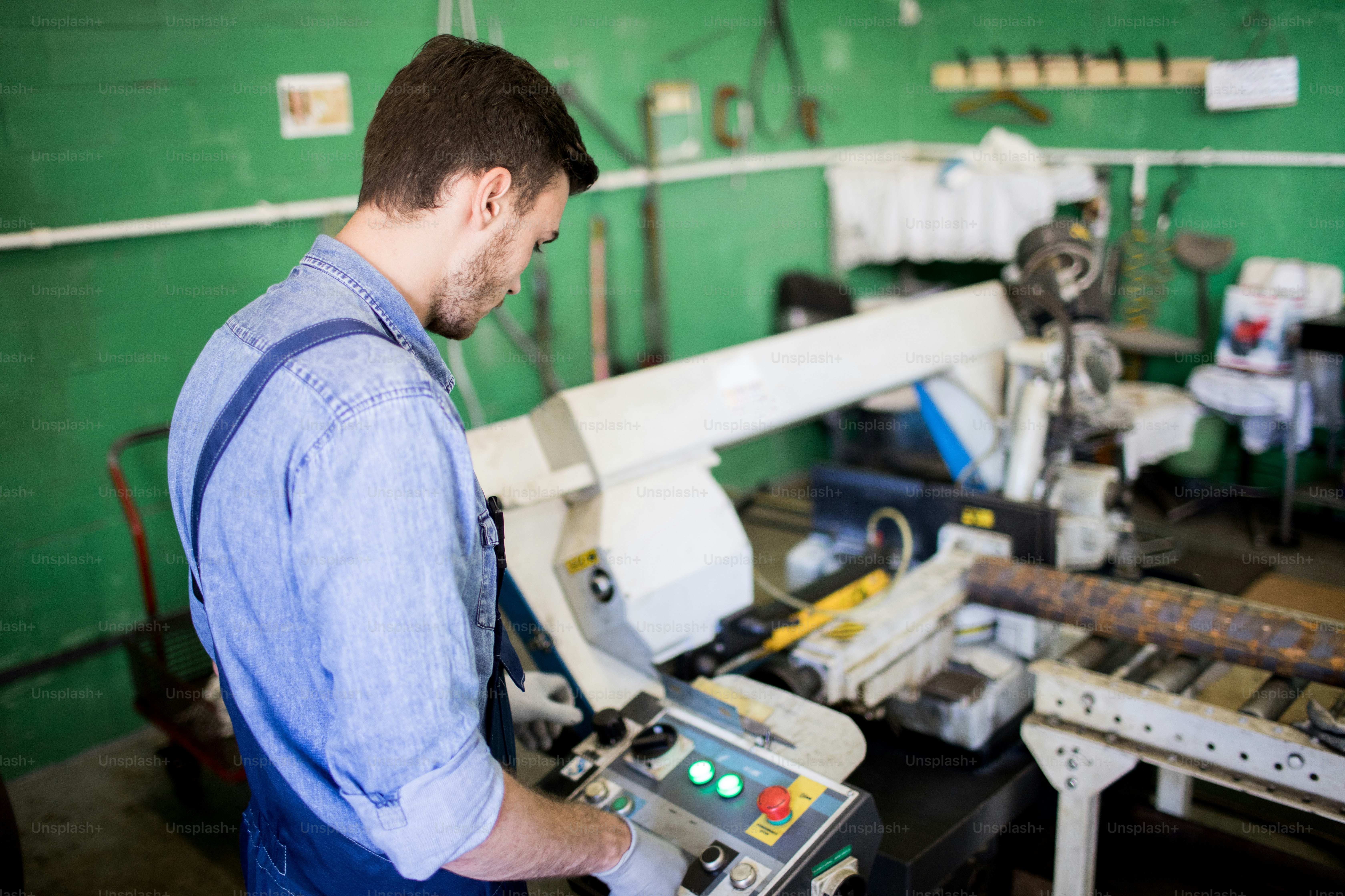 Young operator working on a lathe in the workshop machine factory photo ...