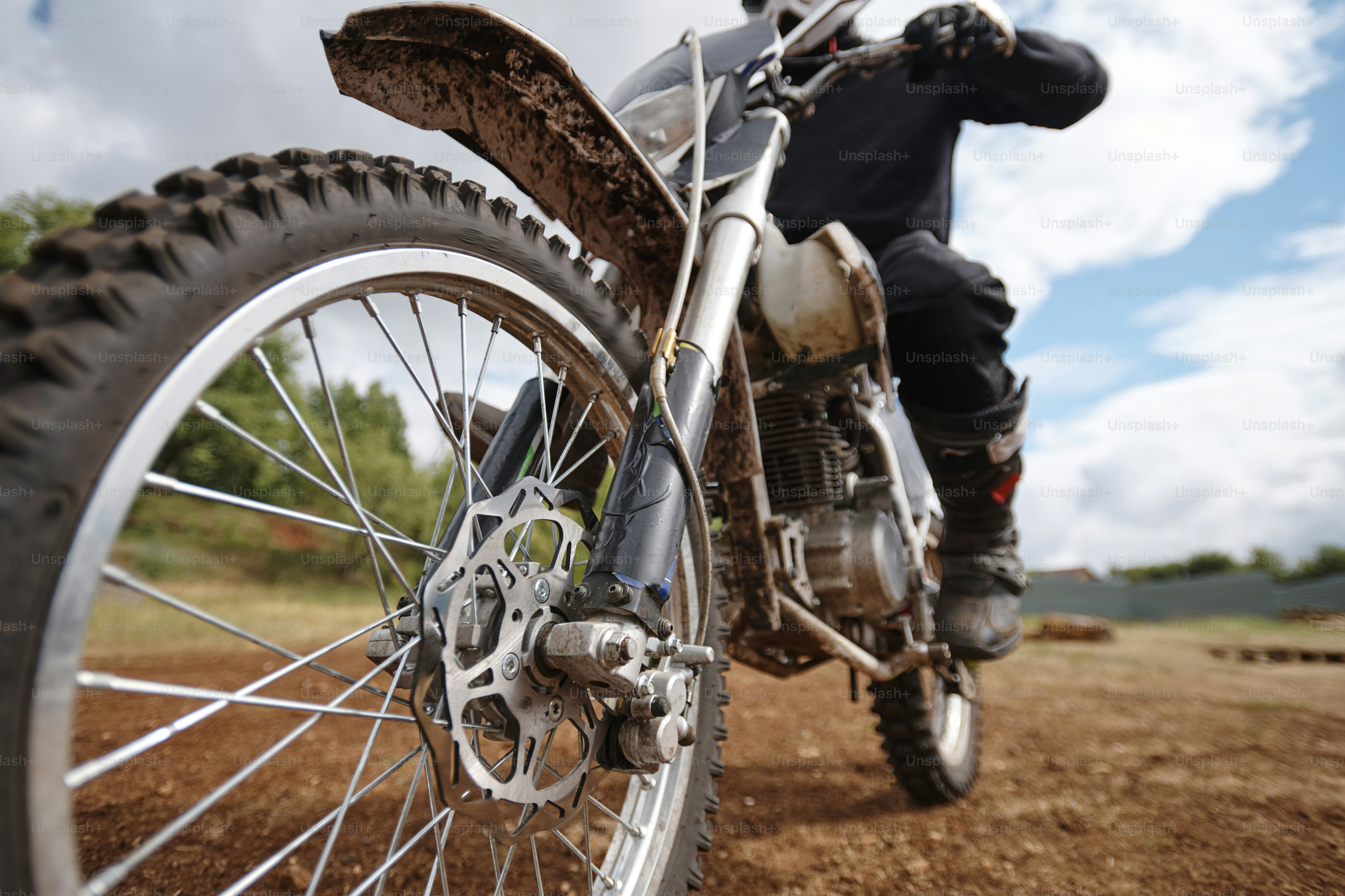 Focus on wheel of brutal motorcycle placed on off-road track, hobby or ...