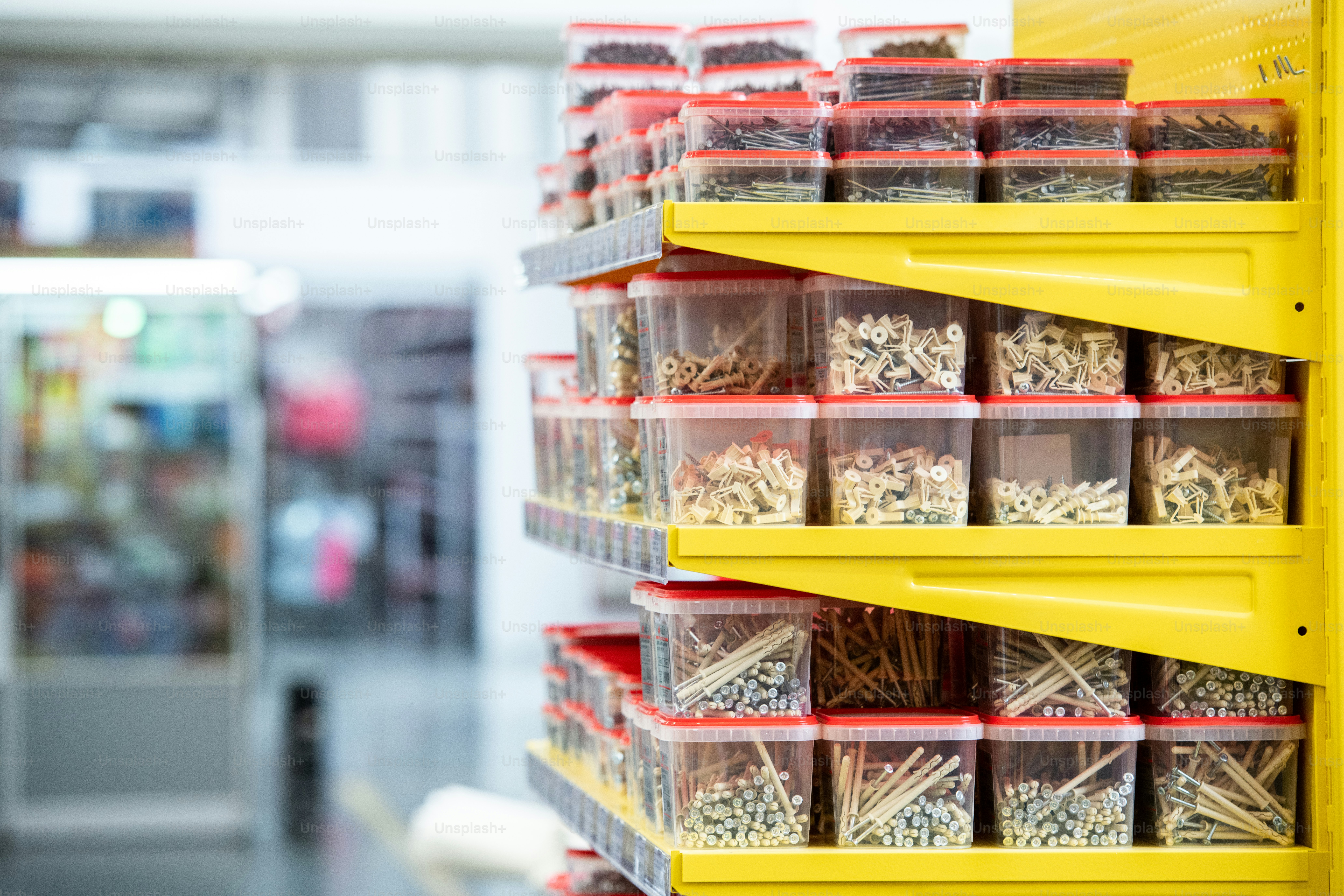 Shelves with nails in stacks of plastic containers in hardware store ...