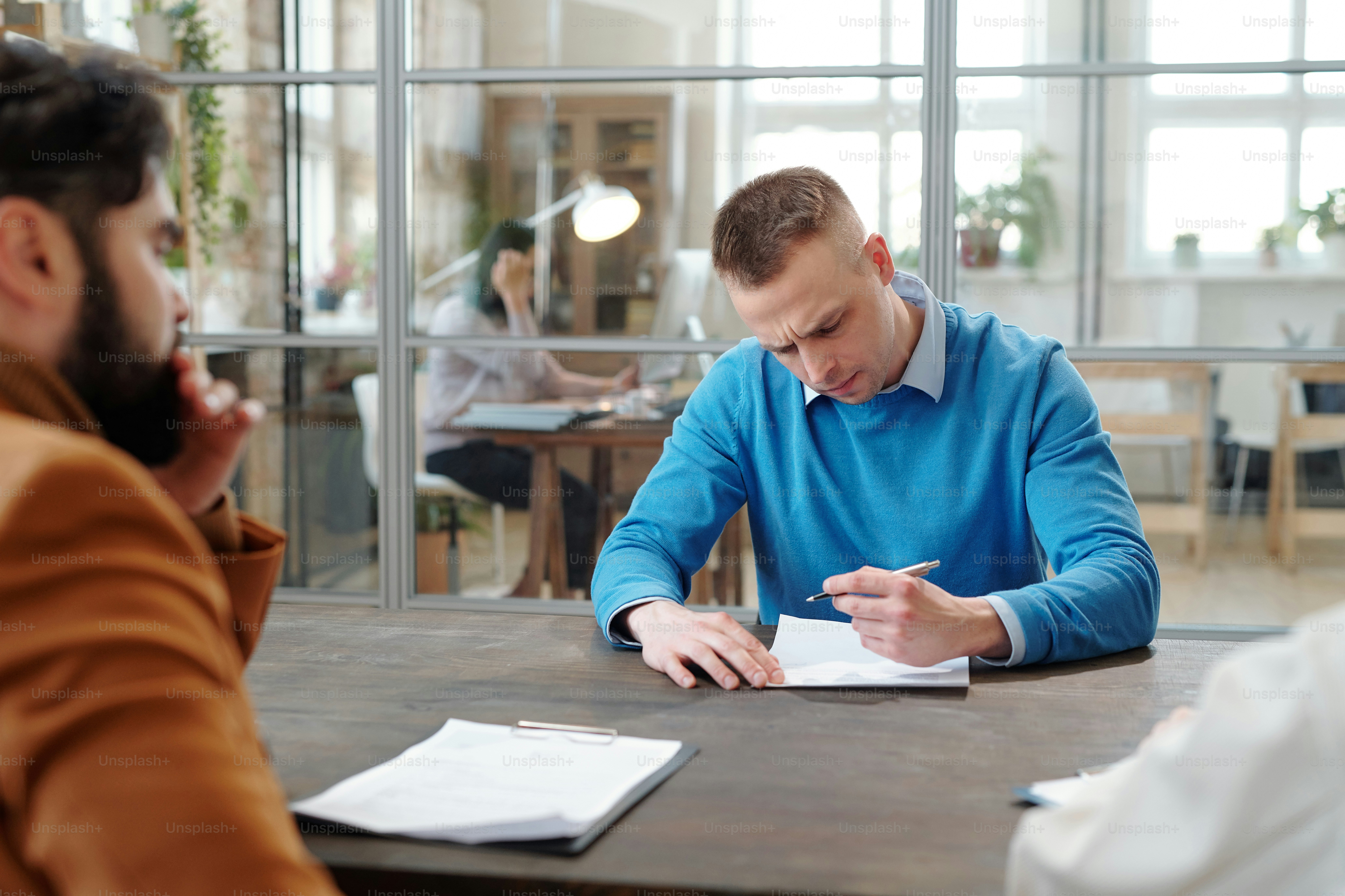Serious applicant signing agreement after interview with employers ...