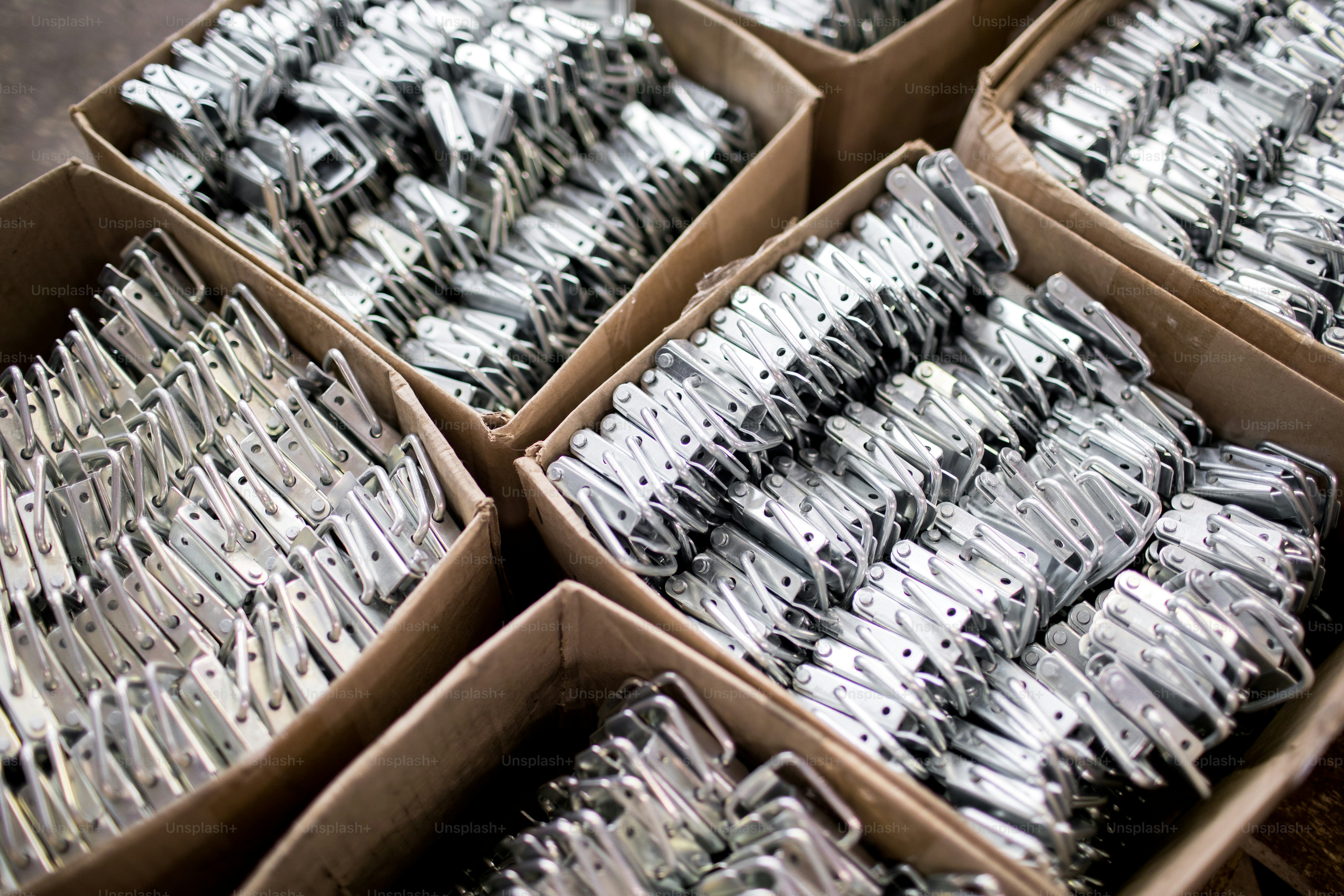 Several carton boxes with rows of steel or metallic details prepared ...