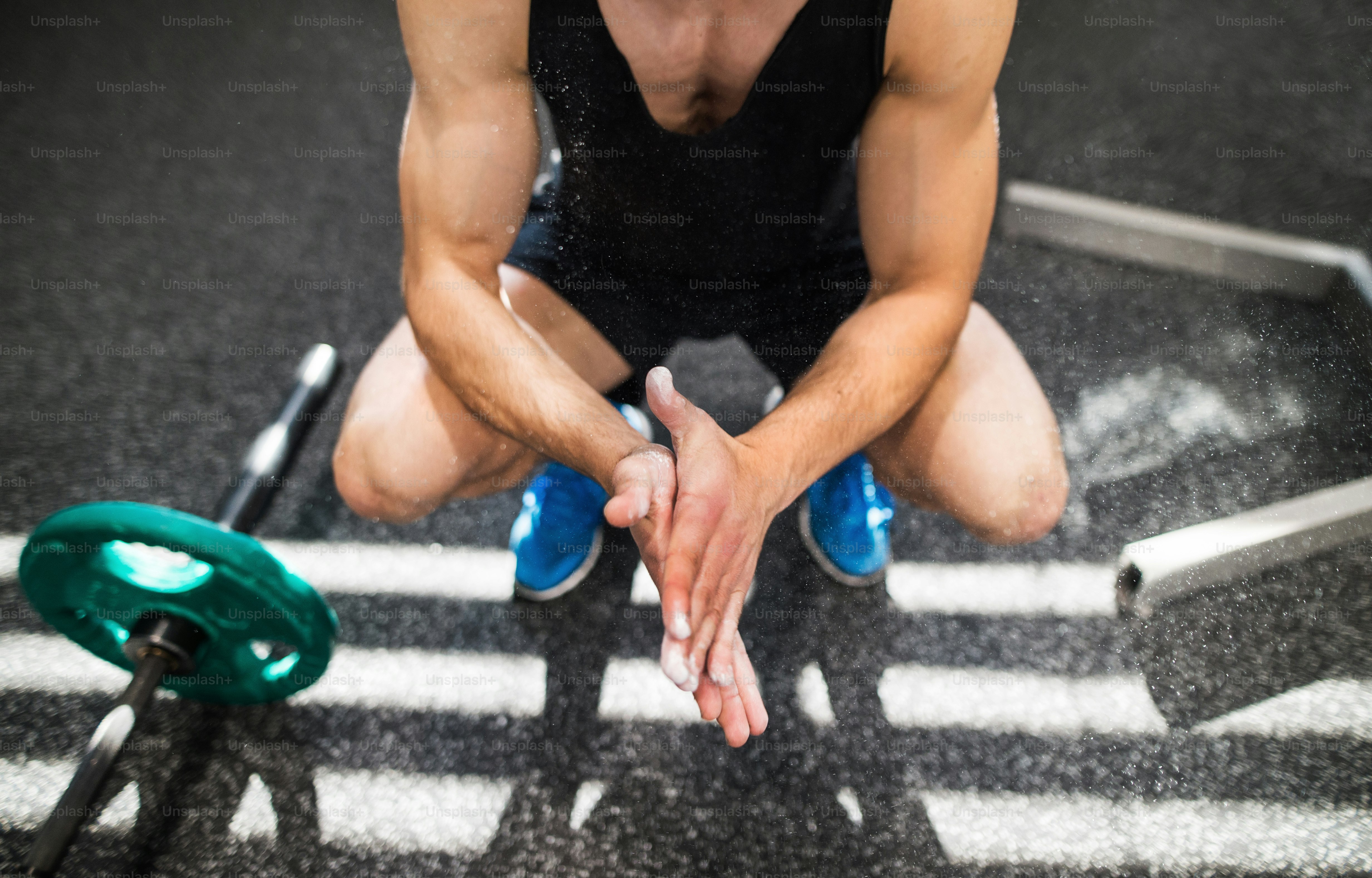 Young fit man in gym working out with climbing rope. Rear view. photo ...