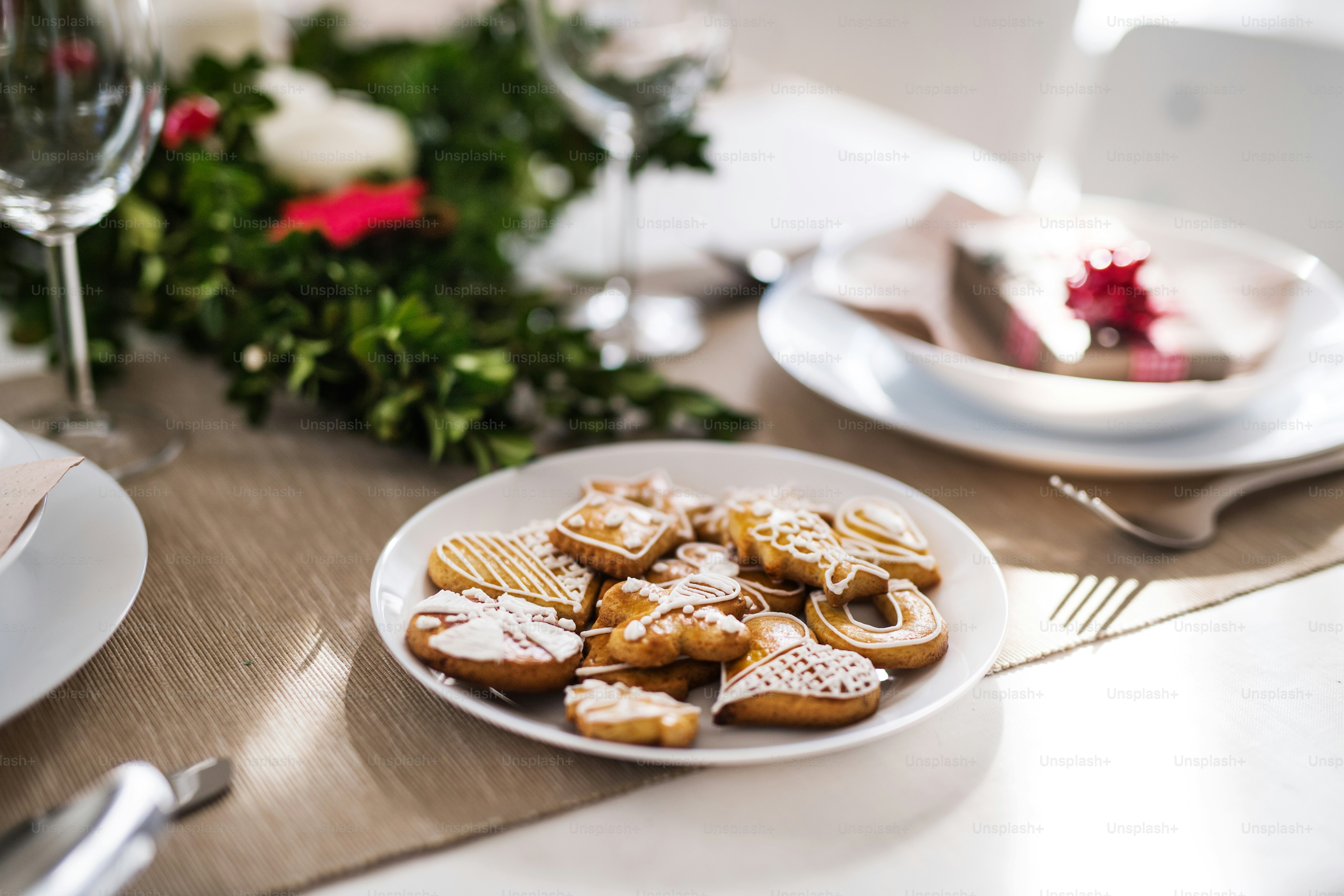 Gingerbread biscuits on a table set for a dinner at home at Christmas ...