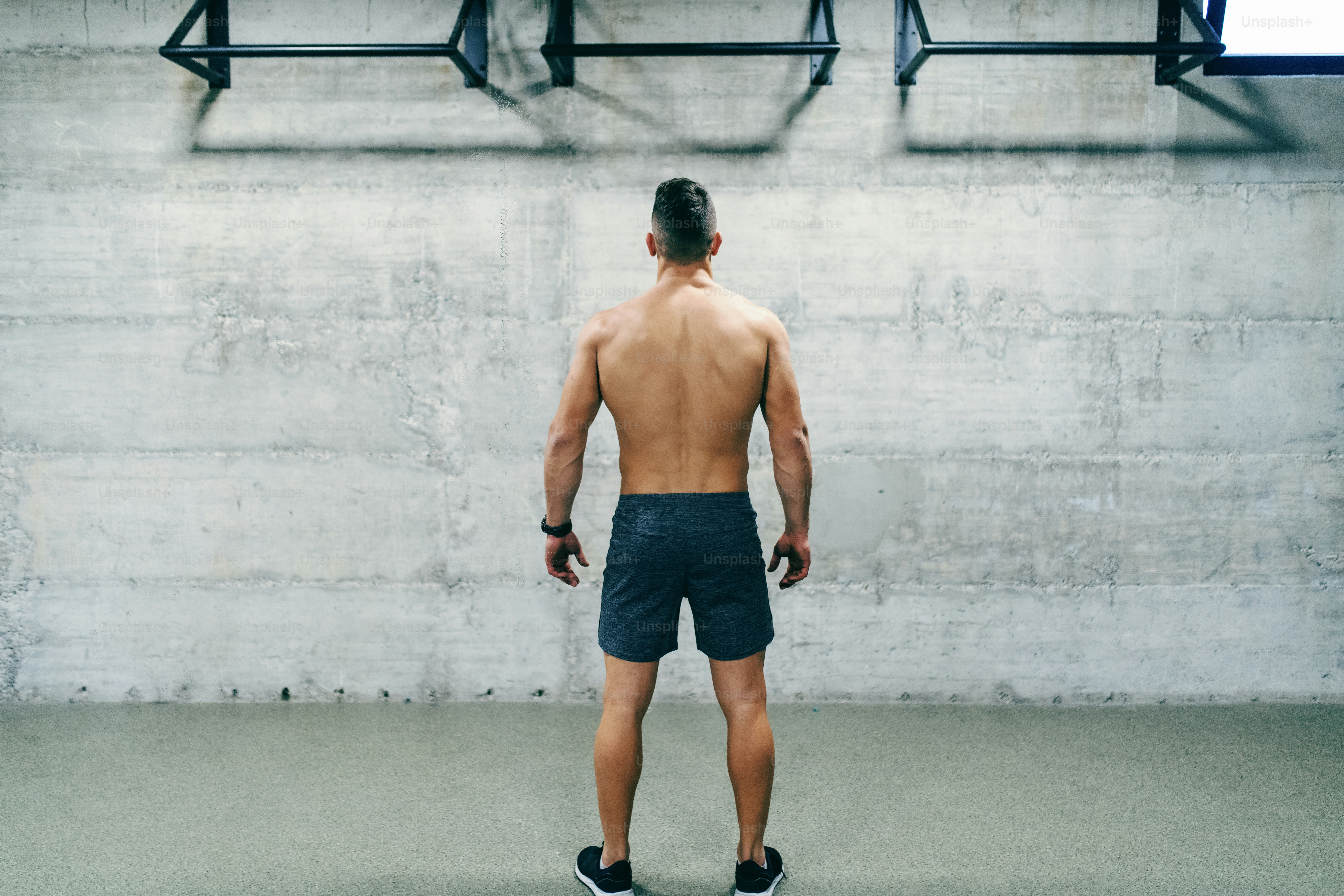 Caucasian bodybuilder preparing to do chin ups. Back turned. photo ...