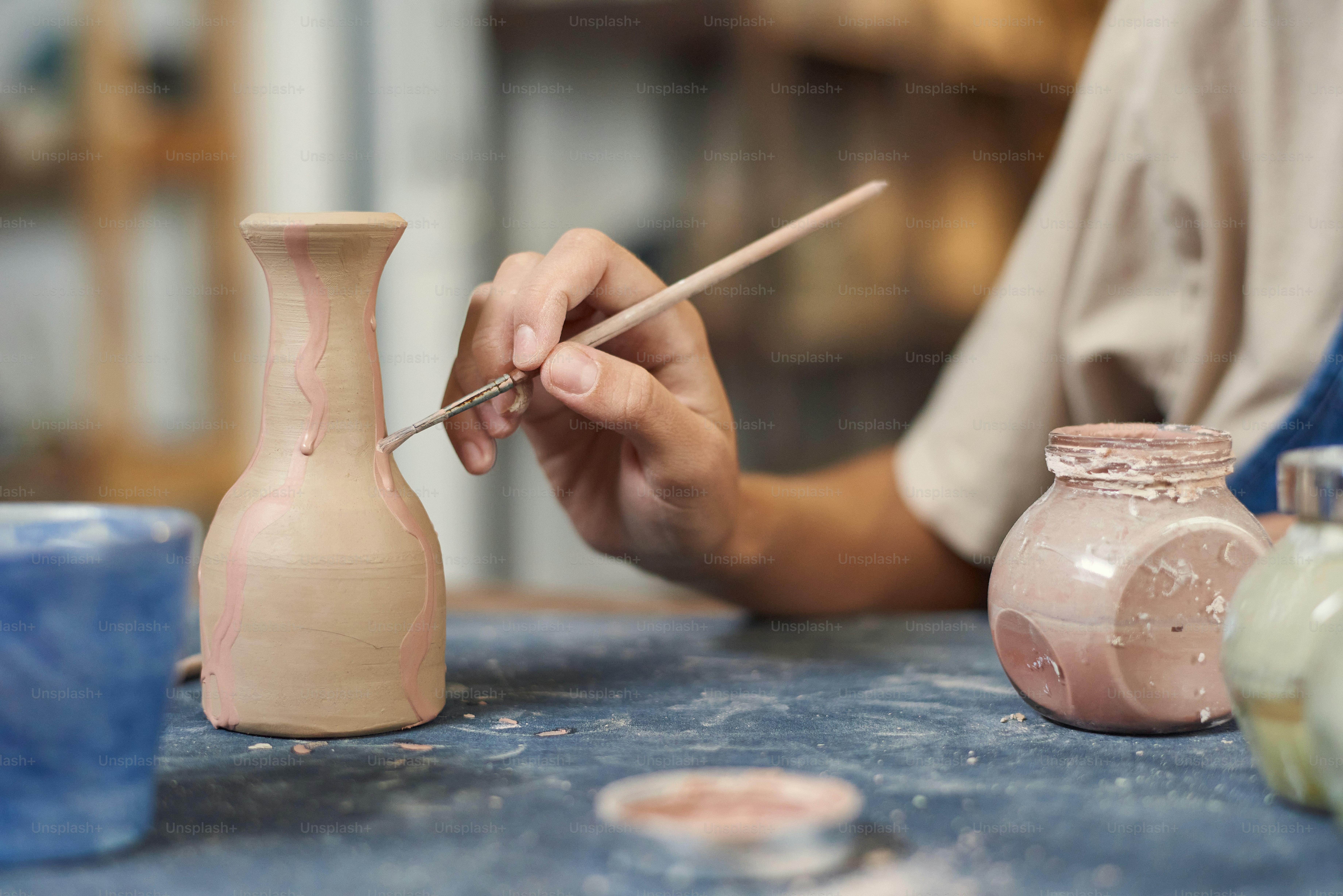 Gros plan d’un potier méconnaissable utilisant un pinceau lors de l ...