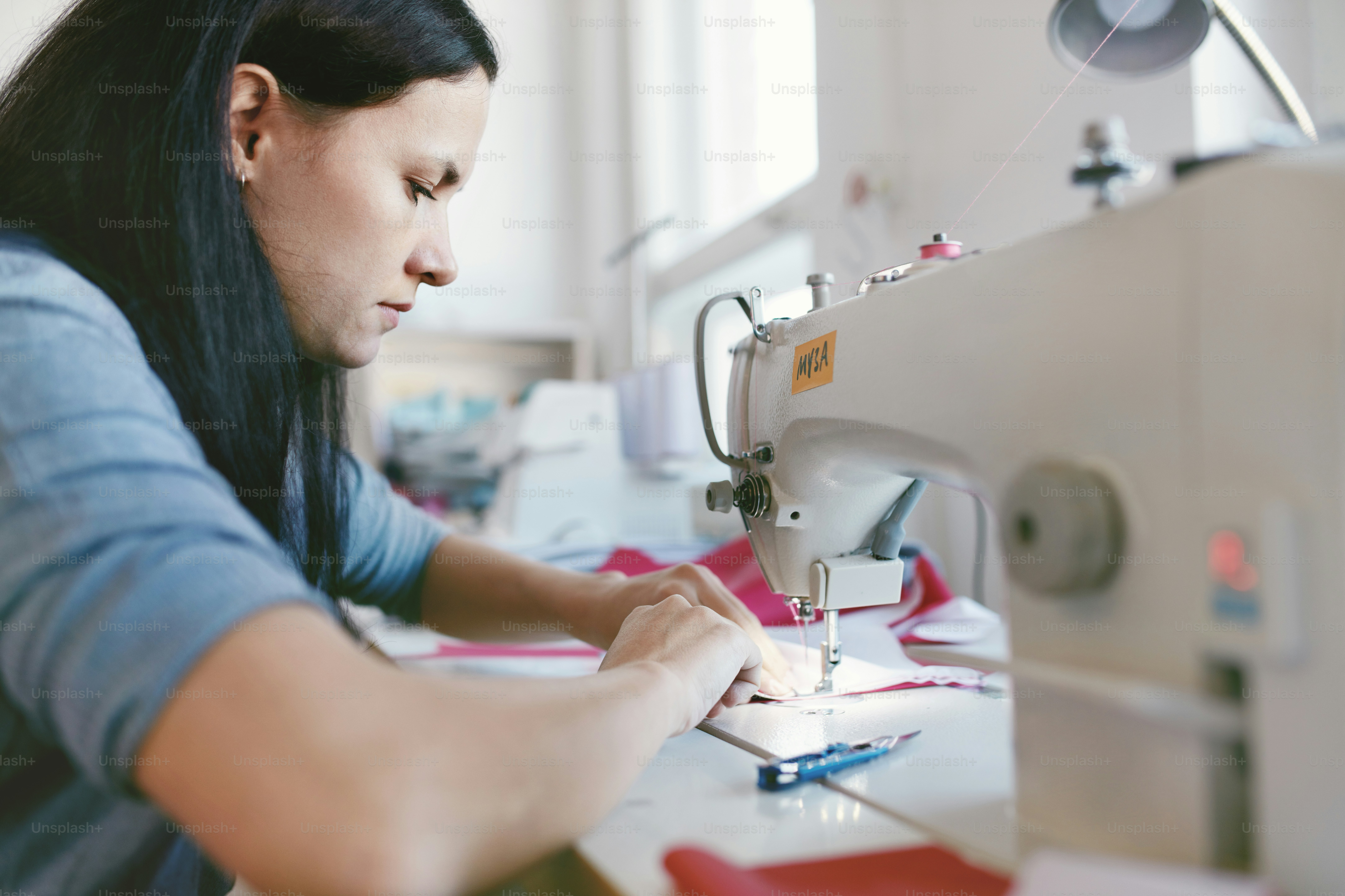 Female Working On Sewing Machine. Portrait Of Woman Tailor Sewing ...