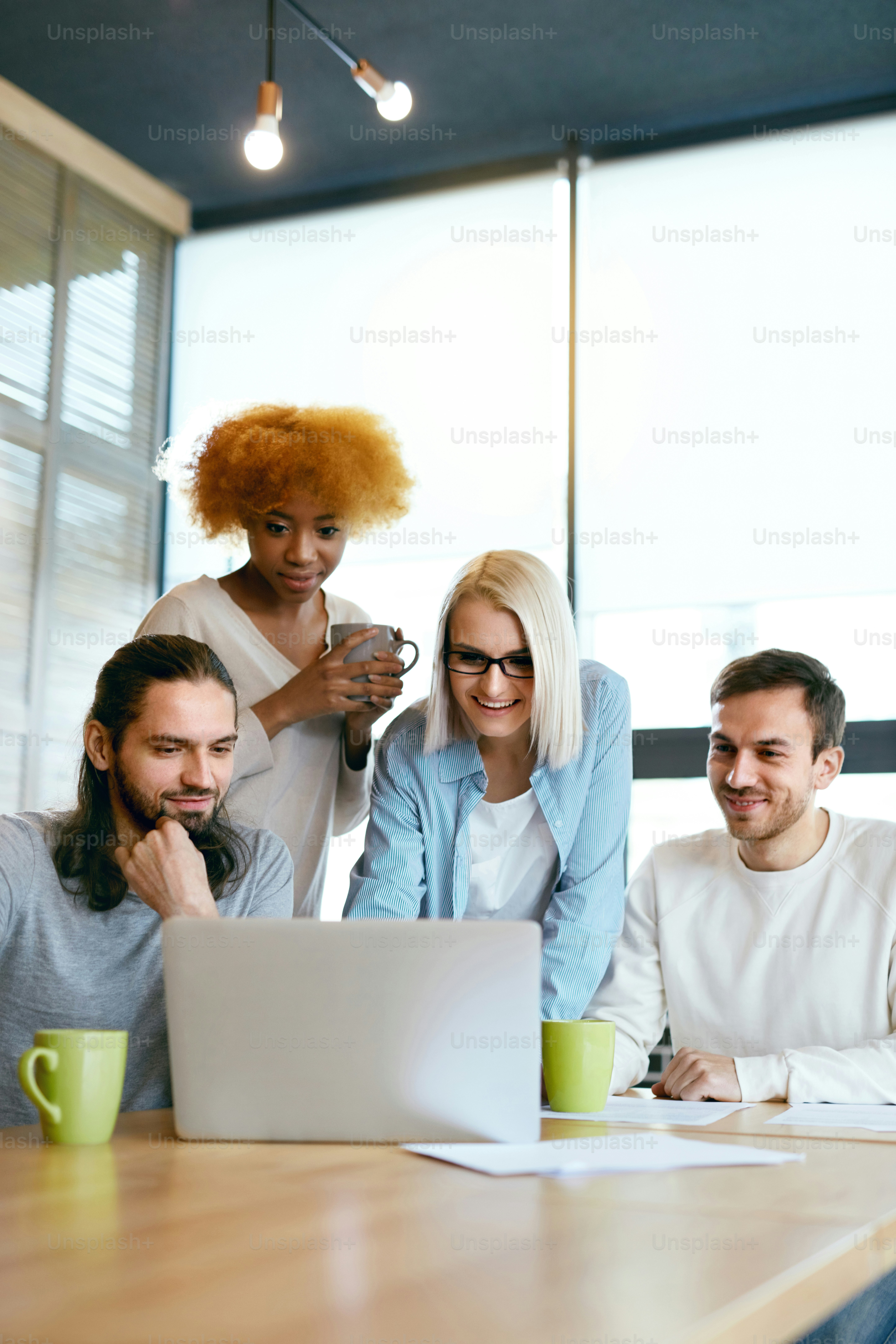 Friends Working Together At Cafe, Using Computer, Drinking Coffee And ...