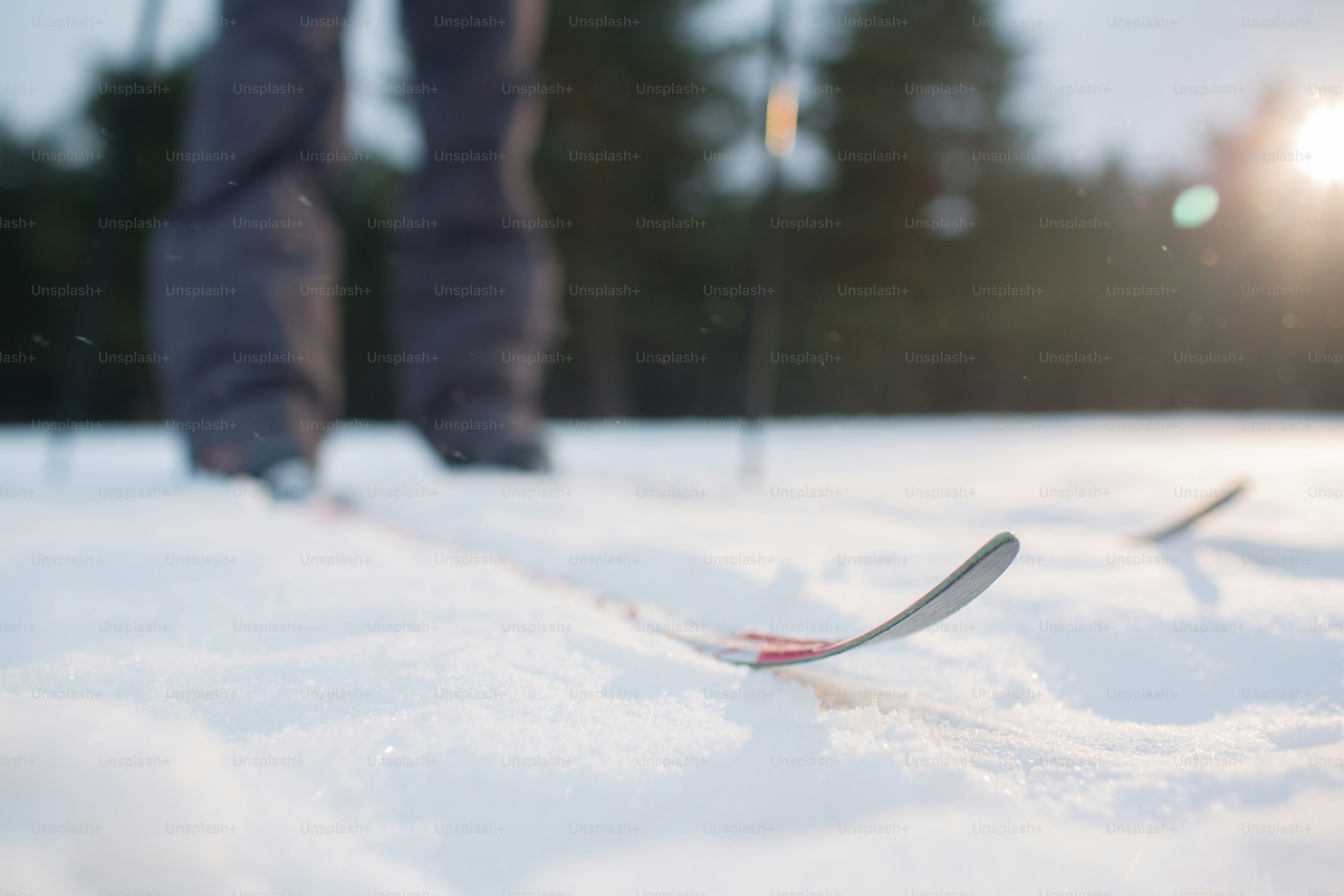 Ski track and human on skis standing on white snow during training in ...
