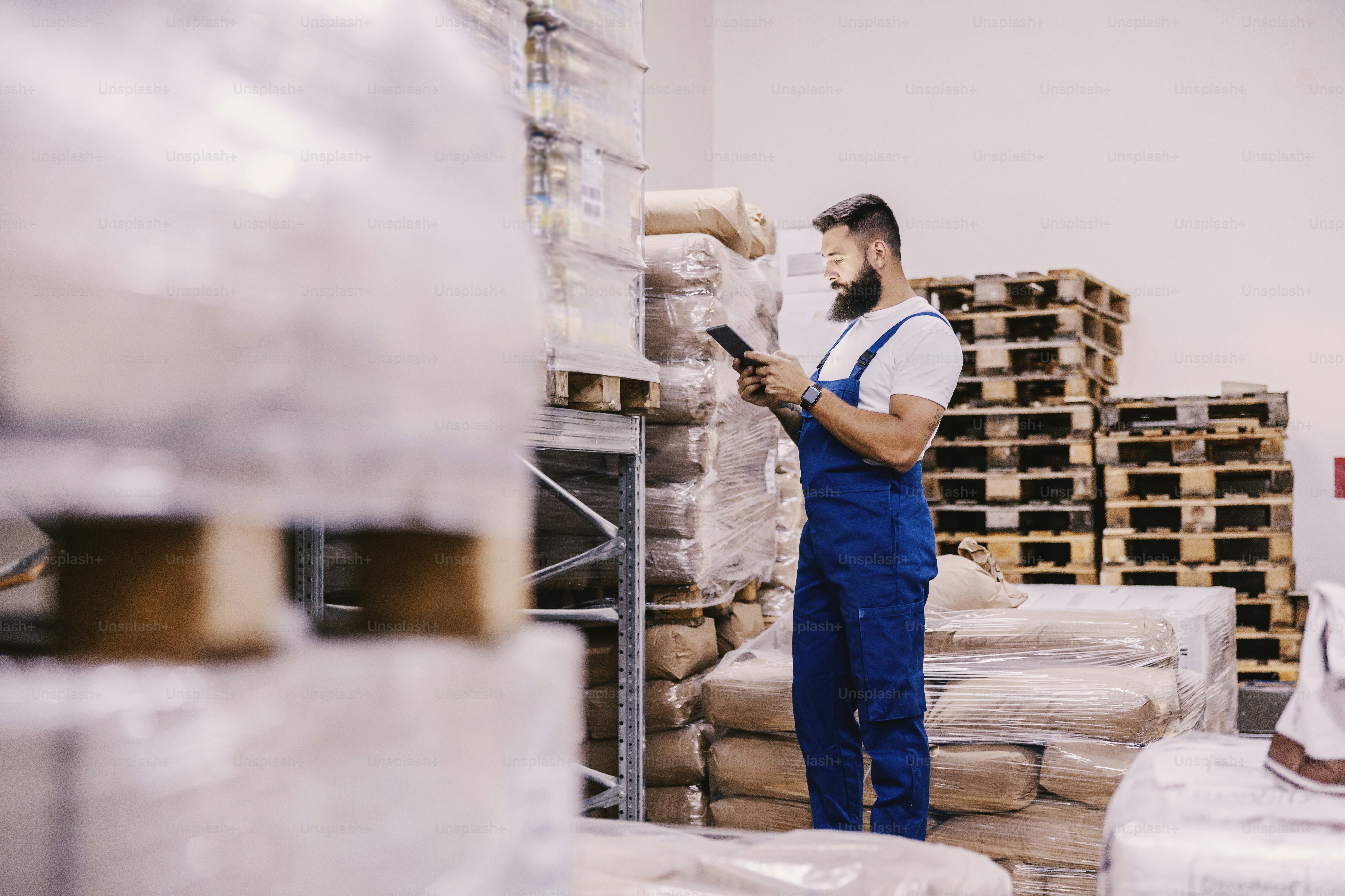 A warehouse worker inventory goods by using tablet. photo – Serbia ...