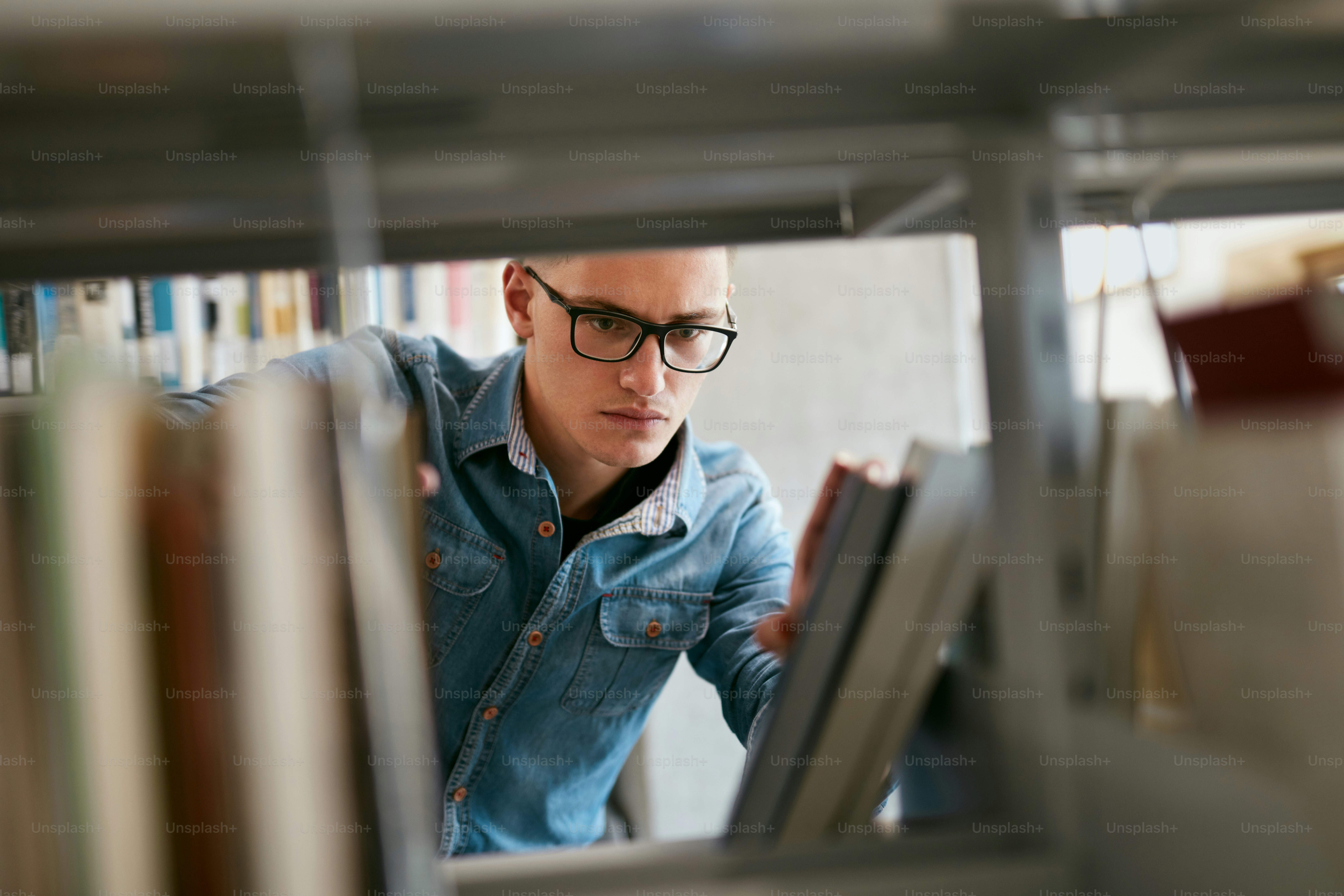 Man Looking For Book In Bookstore. Student In Library Trying To Find ...