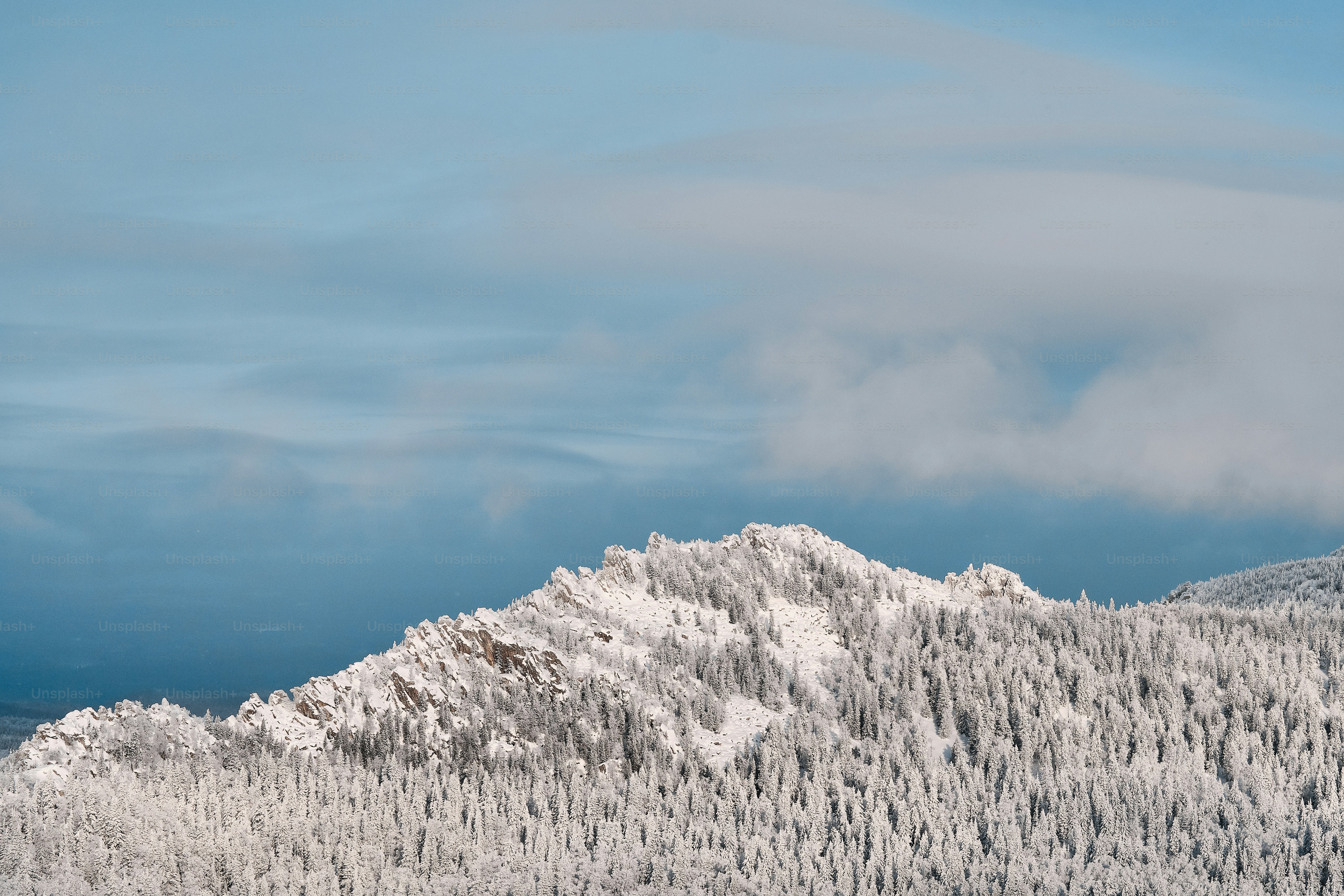 Winter landscape of Taganay mountain chain covered with snow and clouds ...