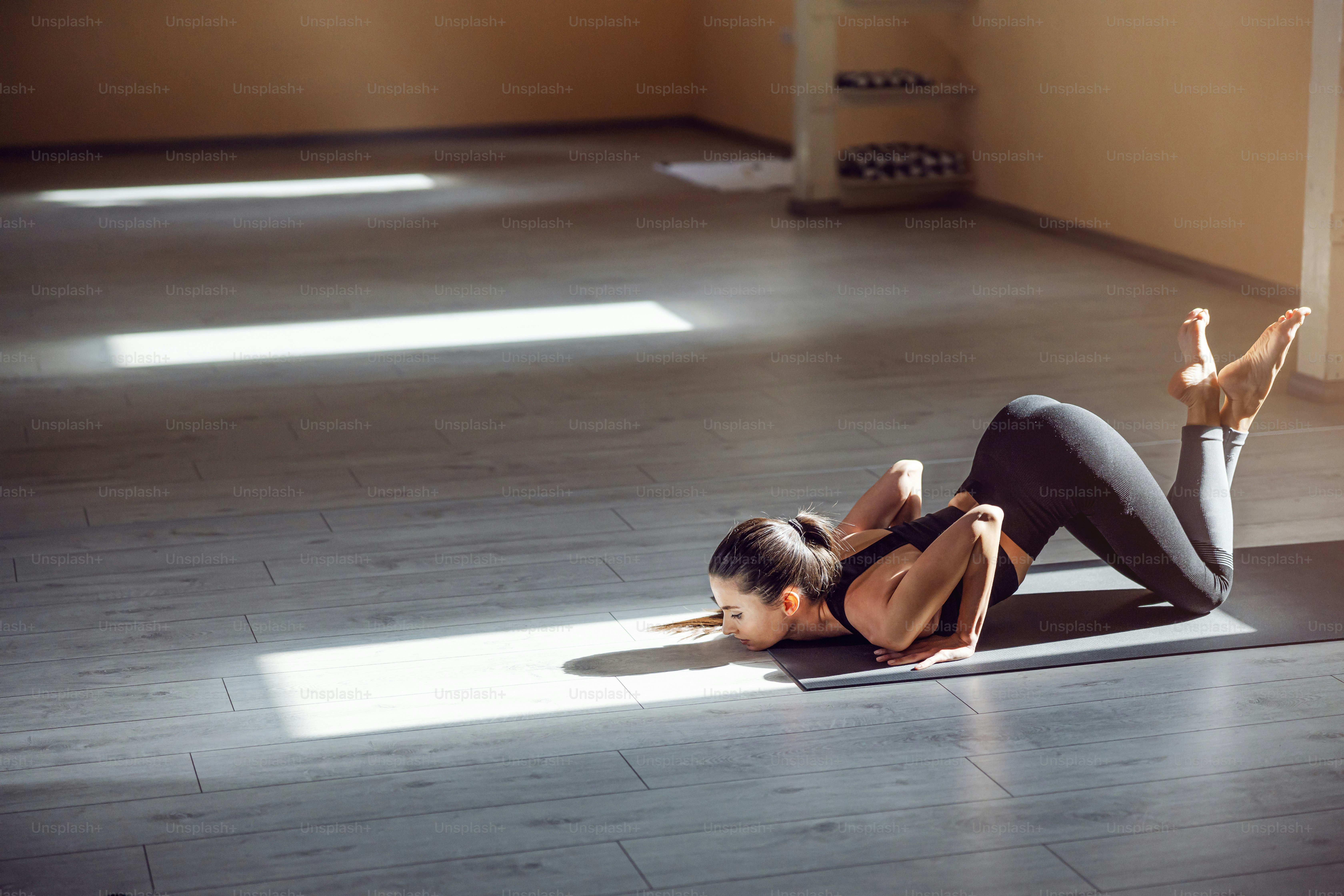 Young dedicated attractive slim yogi girl in Wild Thing yoga pose. Yoga ...