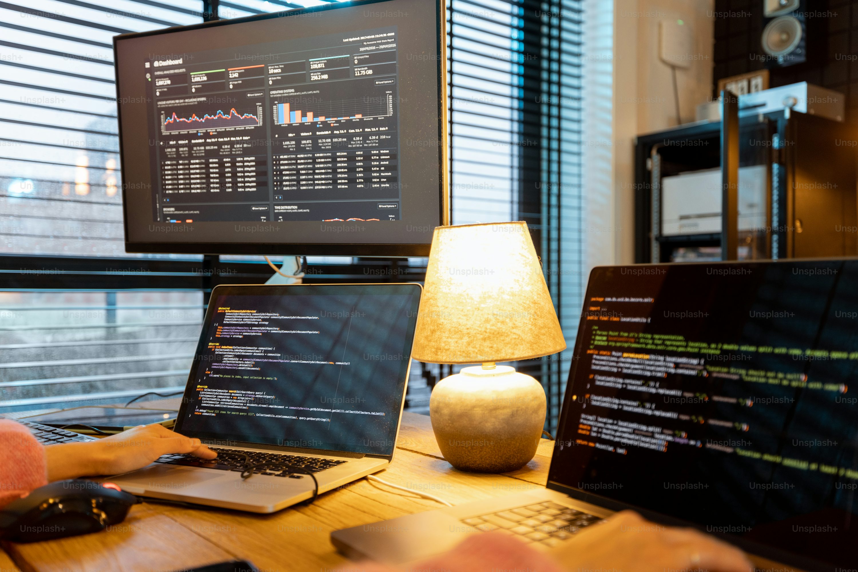 Female programmer writing programming code on laptops and desktop ... Female programmer writing programming code on laptops and desktop ...