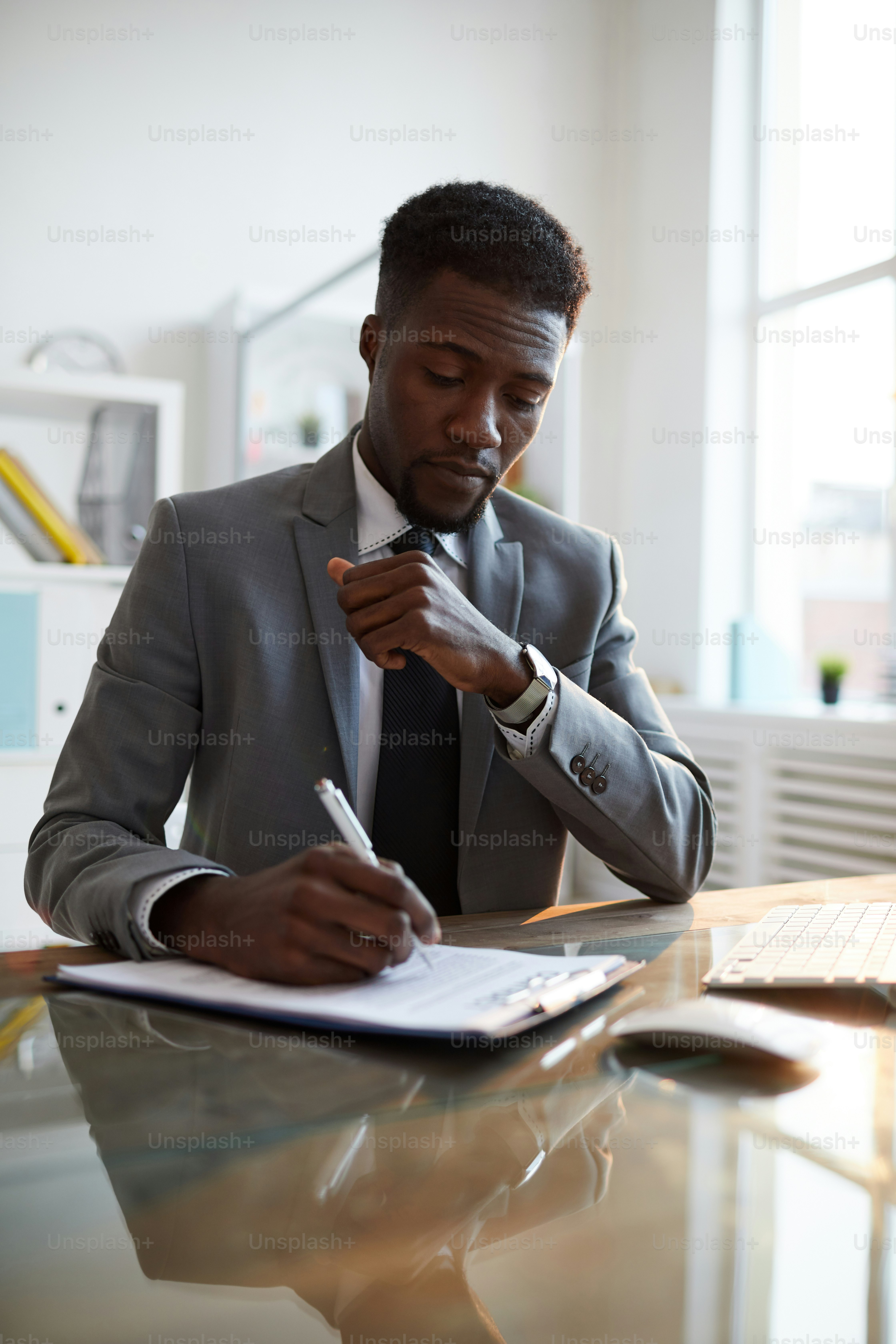 Serious agent or financier with pen reading attentively terms of ...