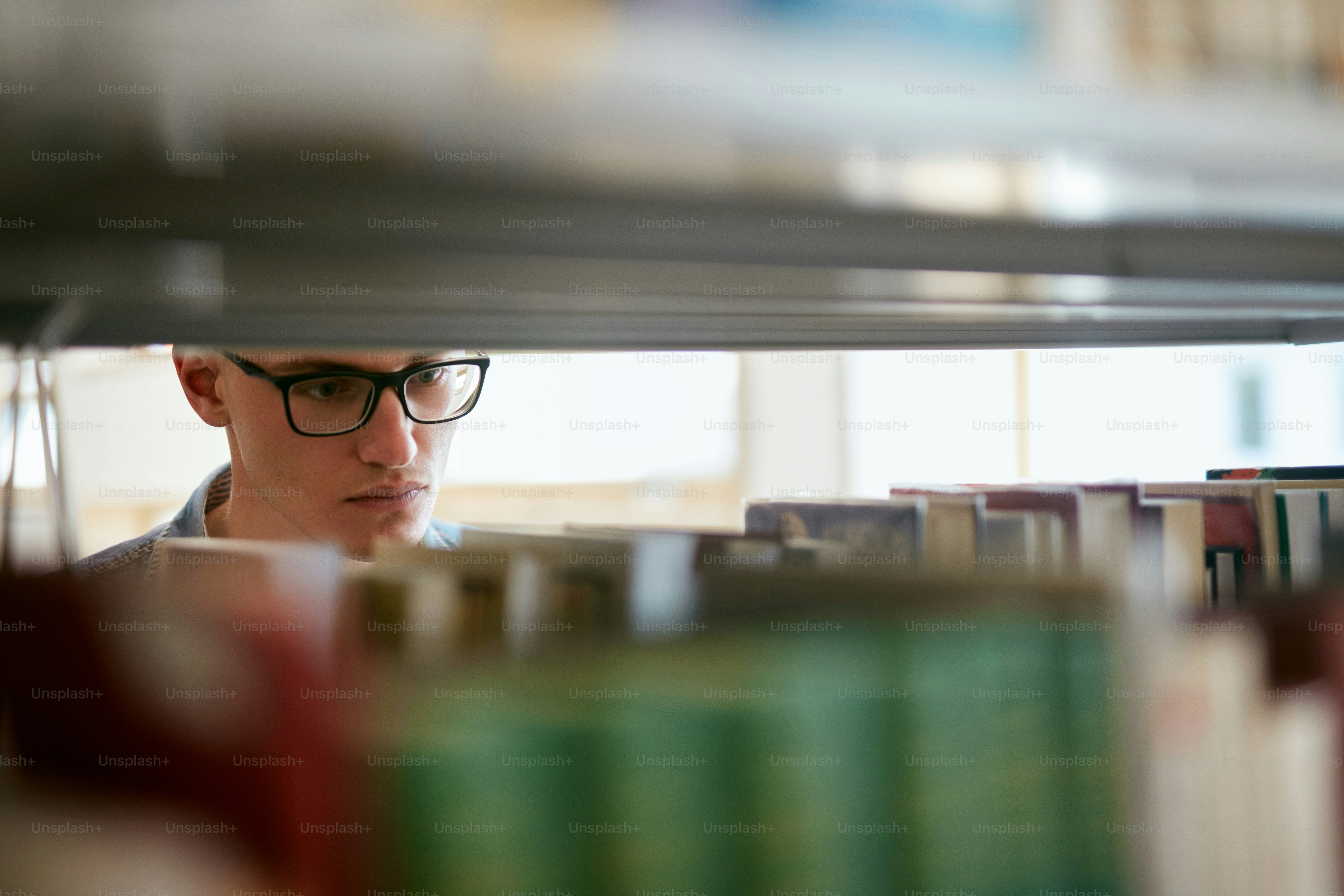 Man Looking For Book In Bookstore. Student In Library Trying To Find ...