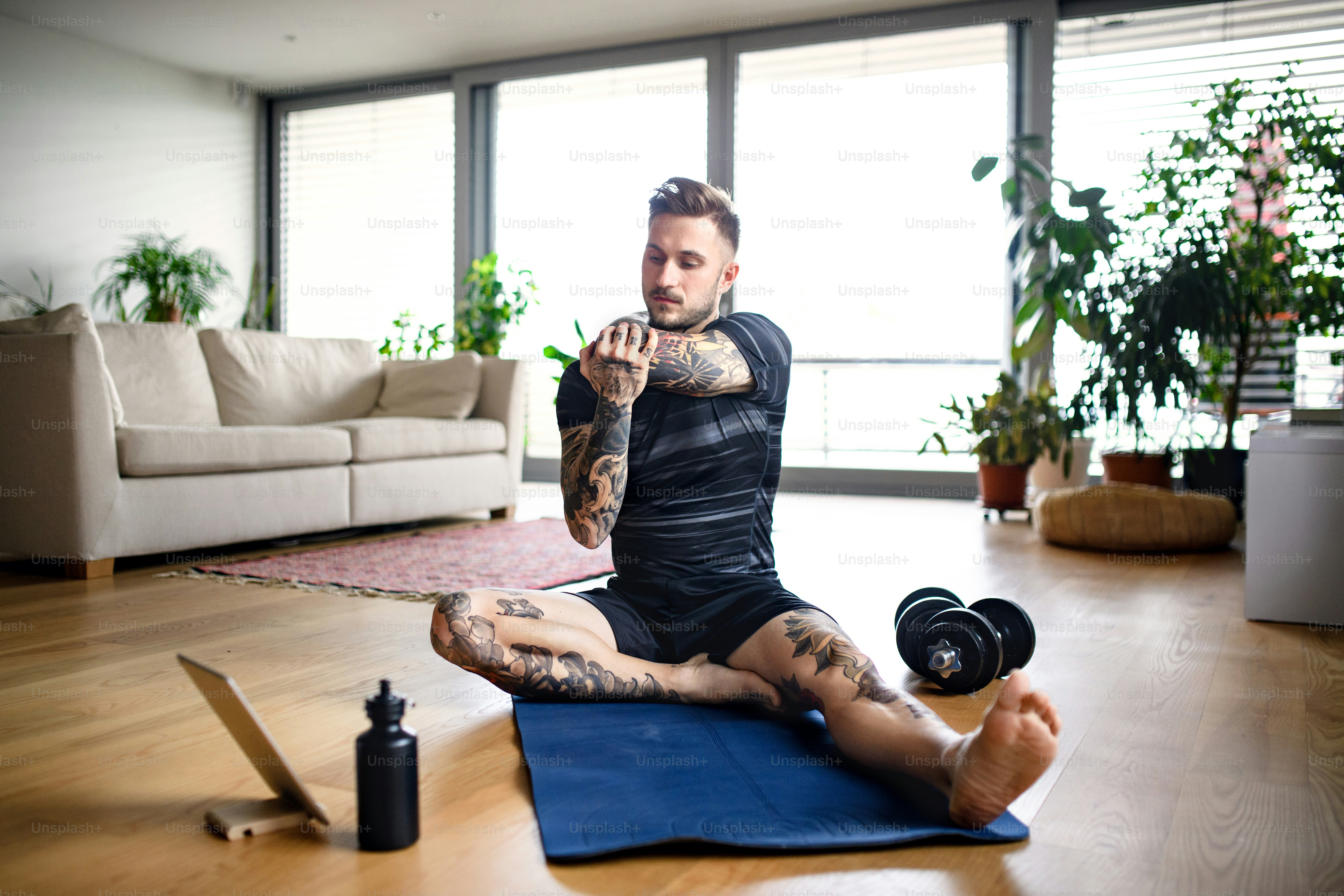 Front view portrait of young man with tablet doing workout exercise ...