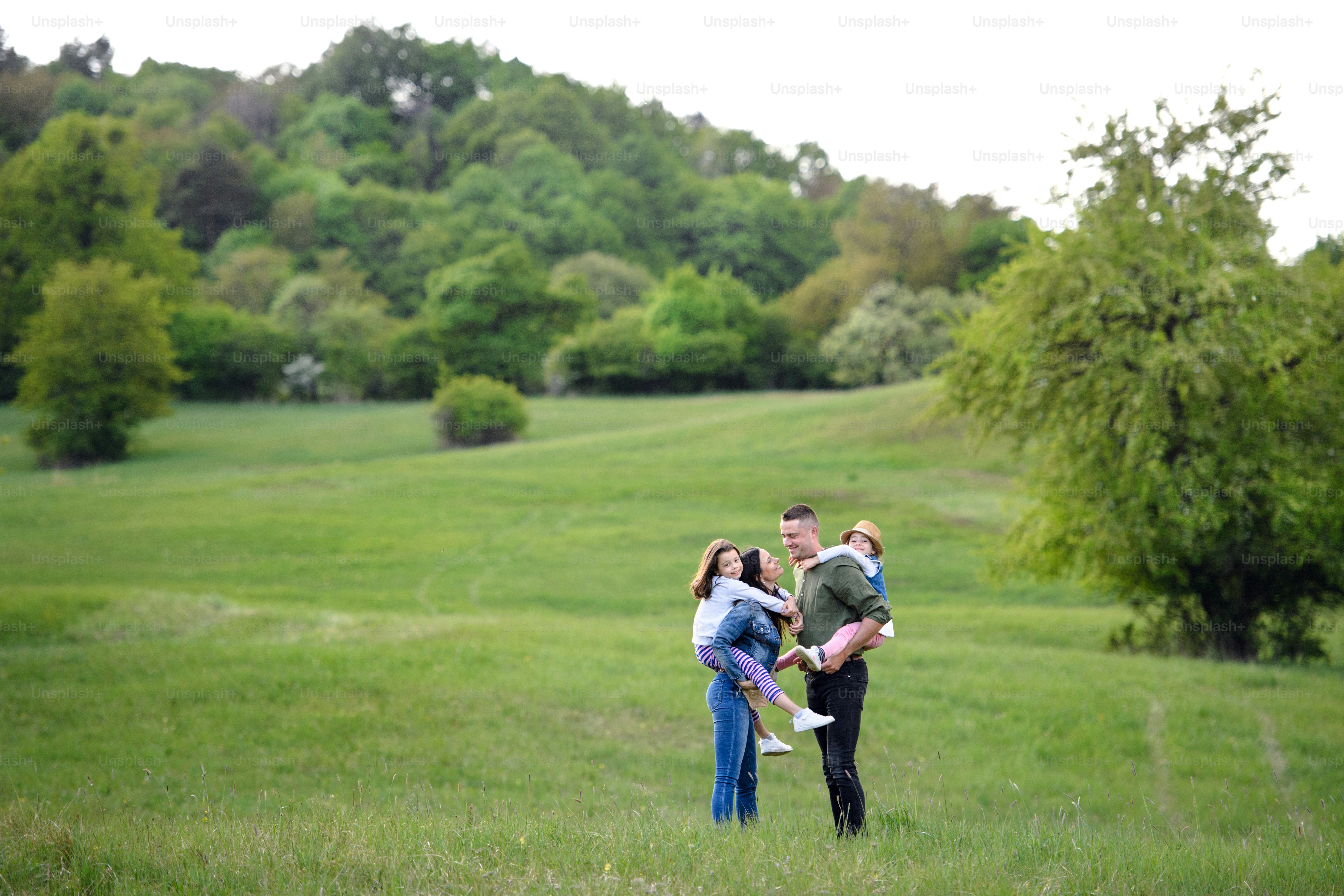 Happy family with two small daughters standing outdoors in spring ...