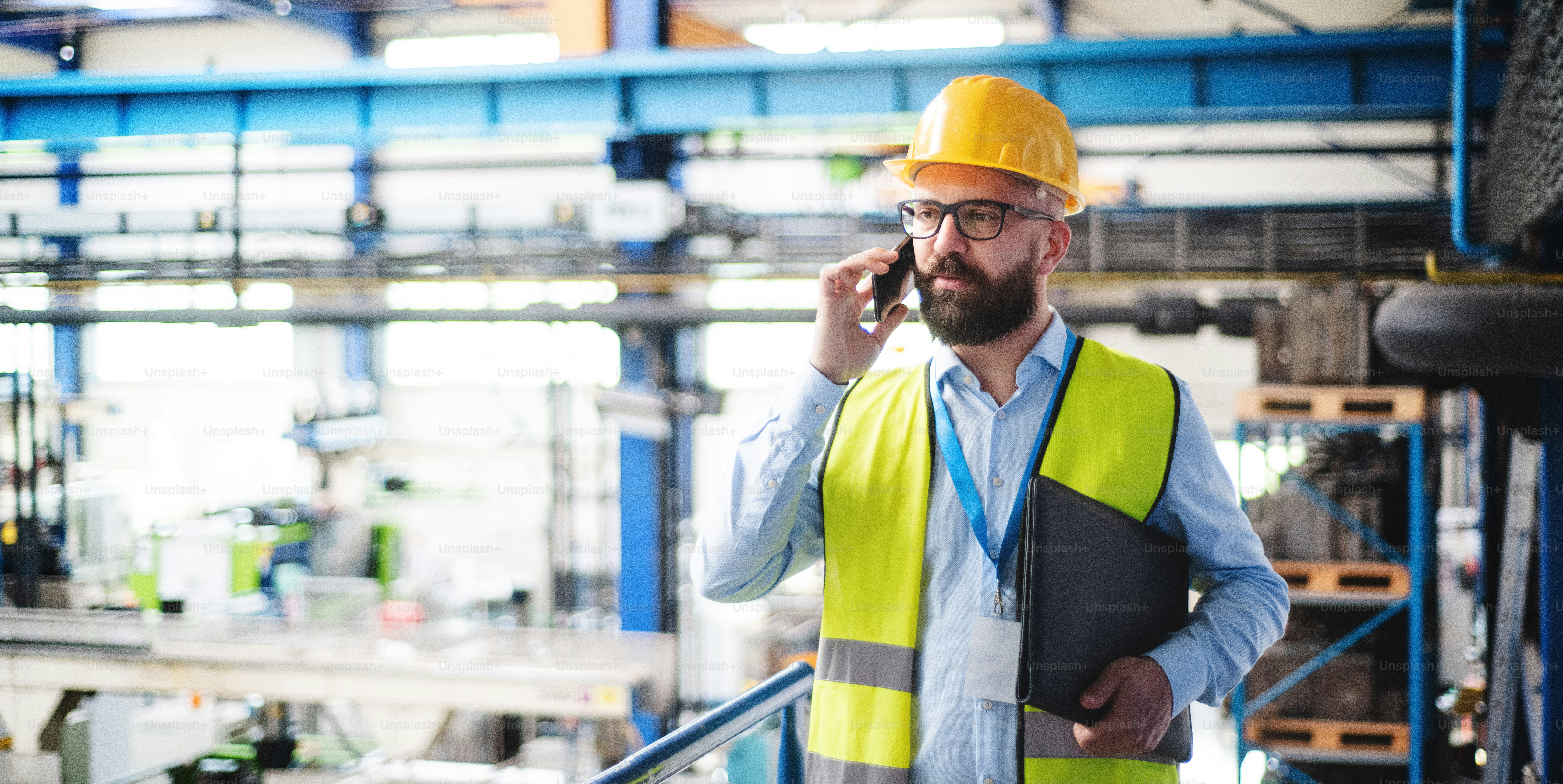 Man technician or engineer with protective mask and telephone working ...