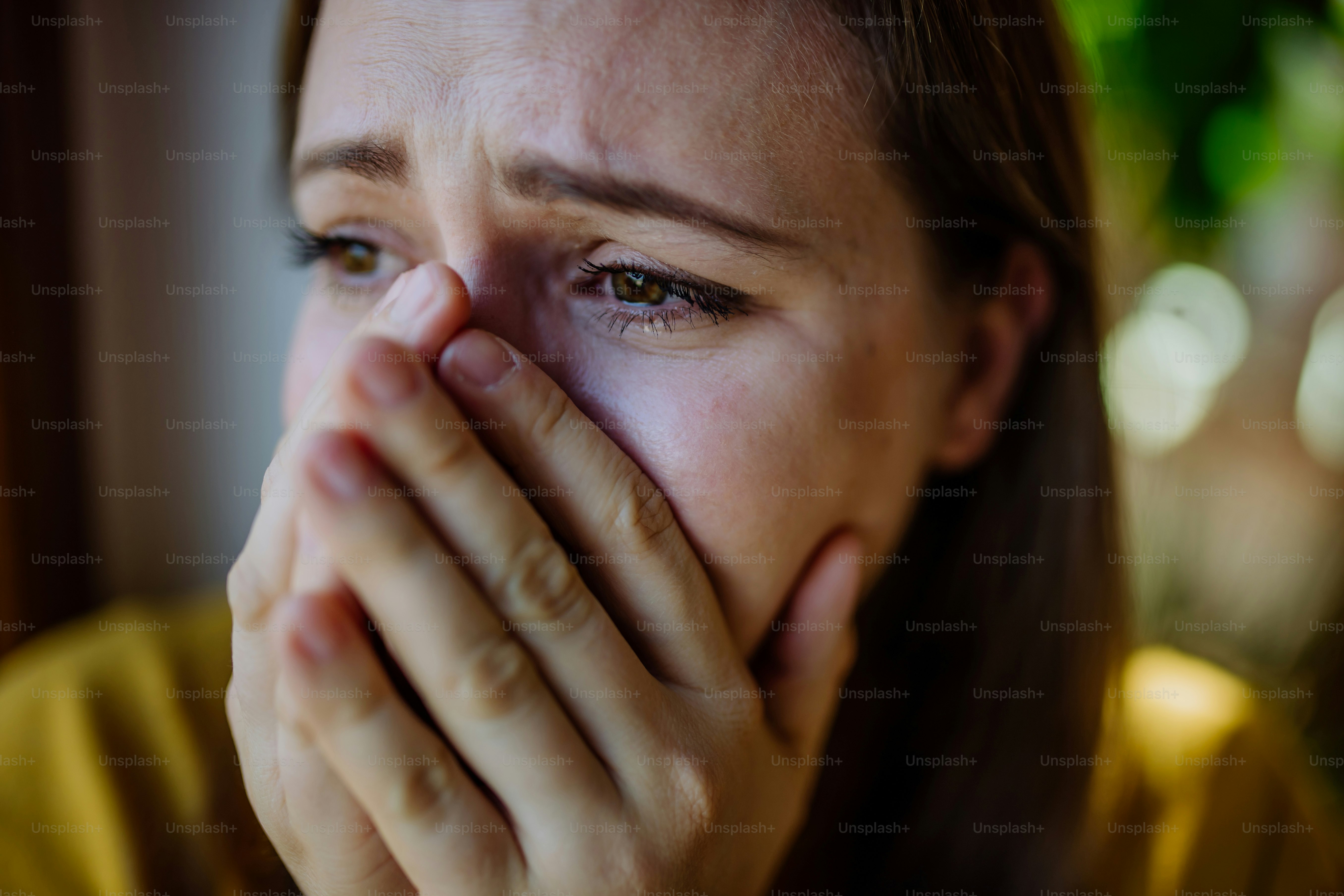 A woman suffering from depression and crying at home. photo – One ...