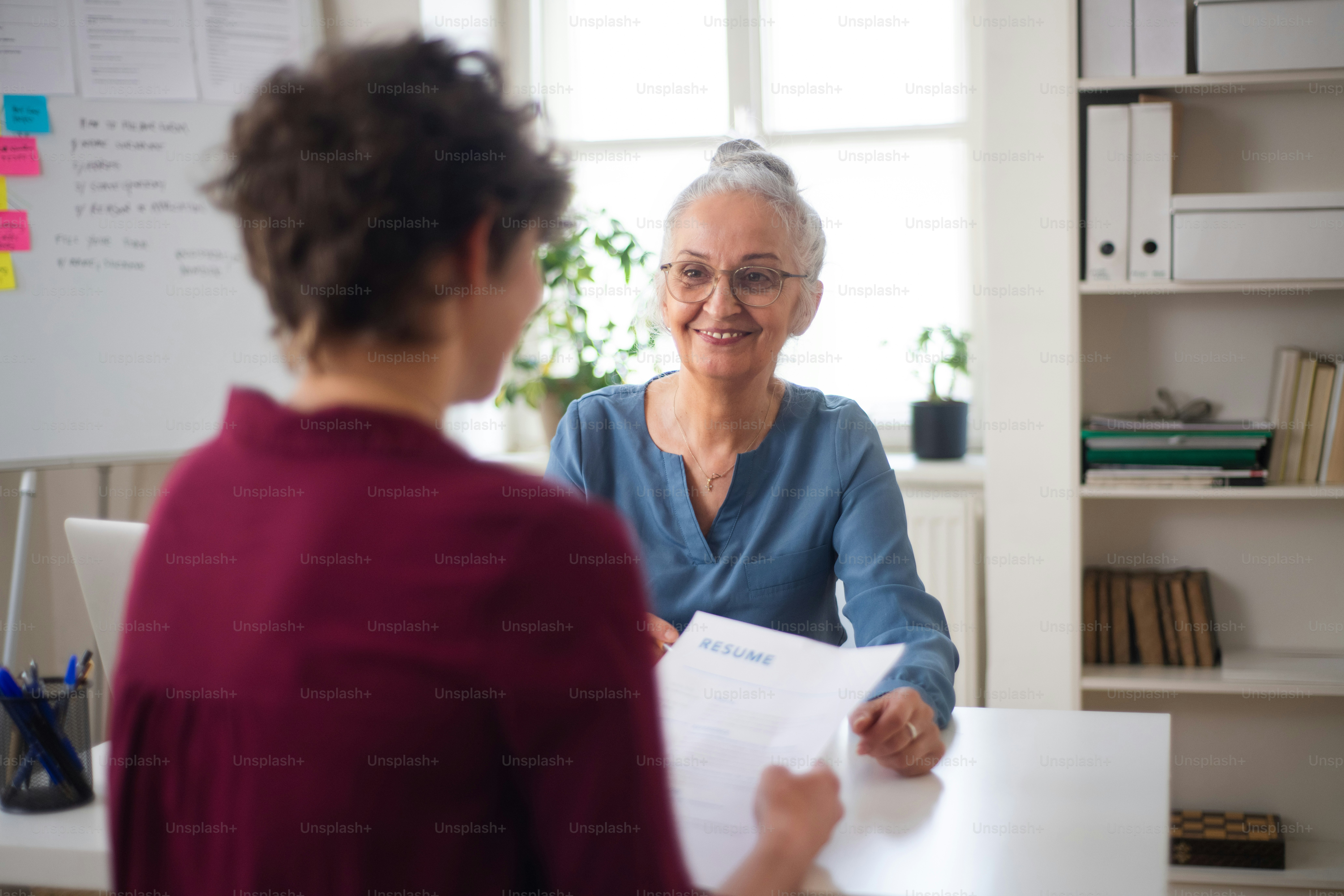 A senior woman recruiter smiling during the job interview. photo ...