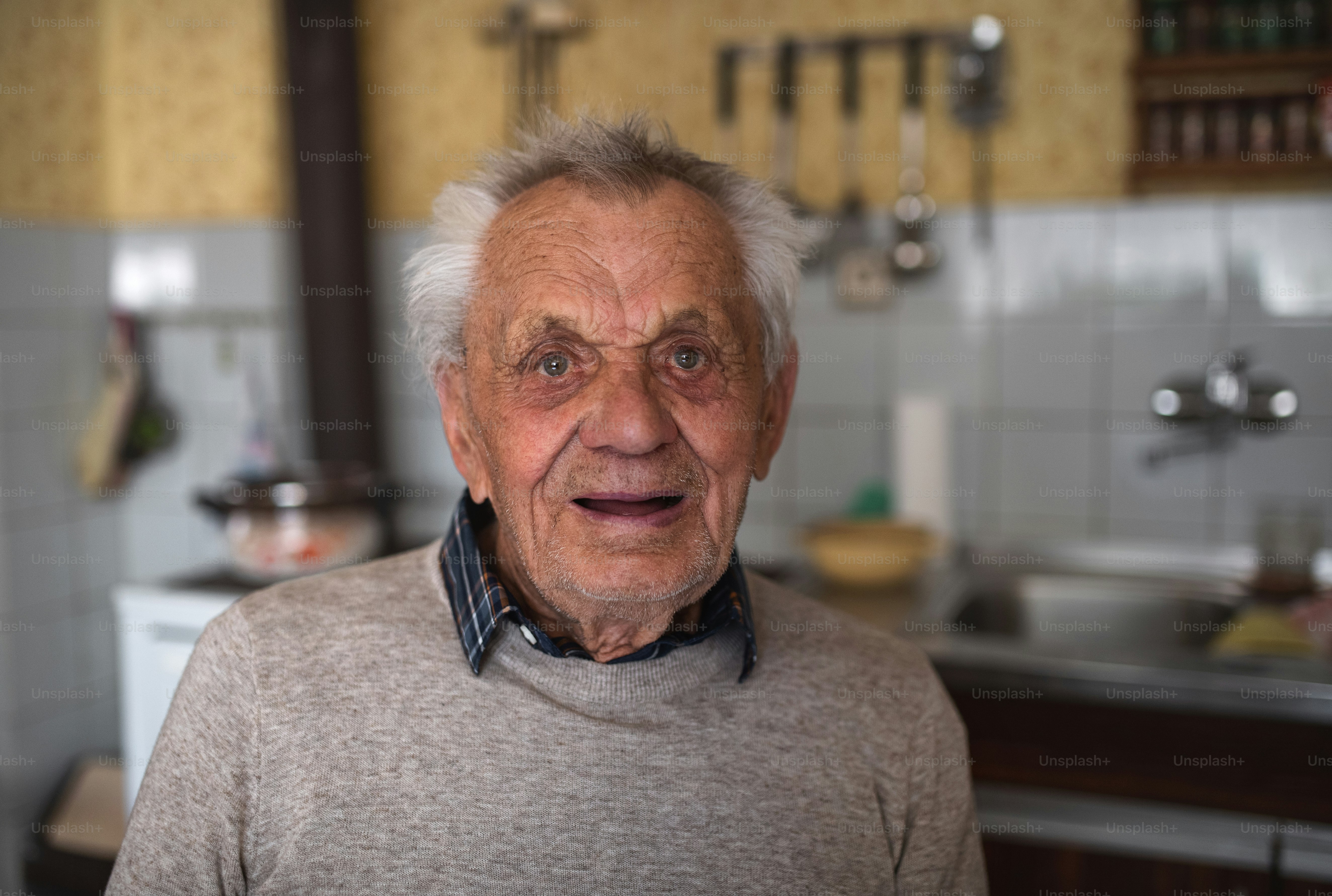 A portrait of elderly man standing indoors at home, laughing. photo ...