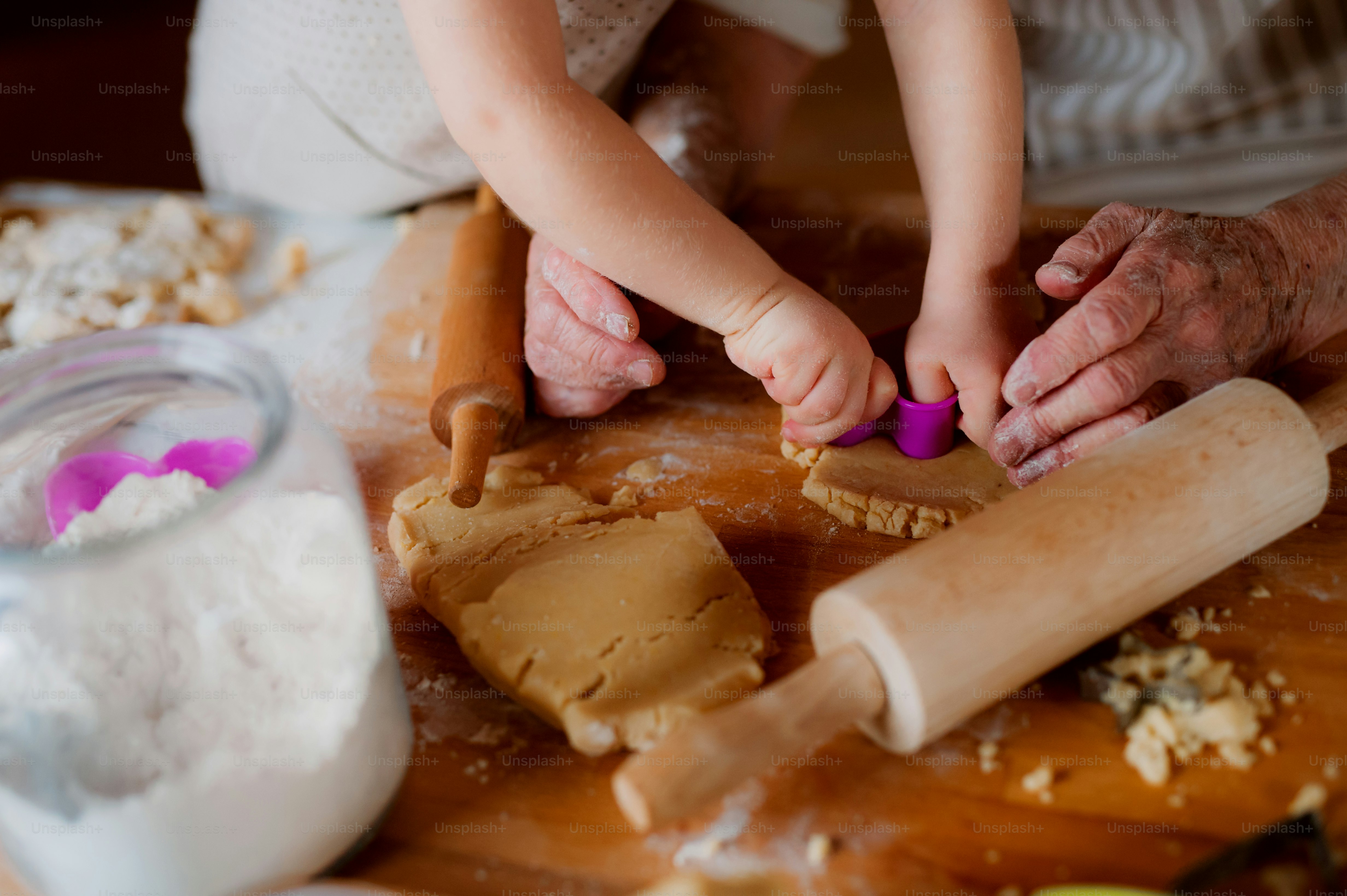 A midsection of senior great grandmother with small toddler boy making ...