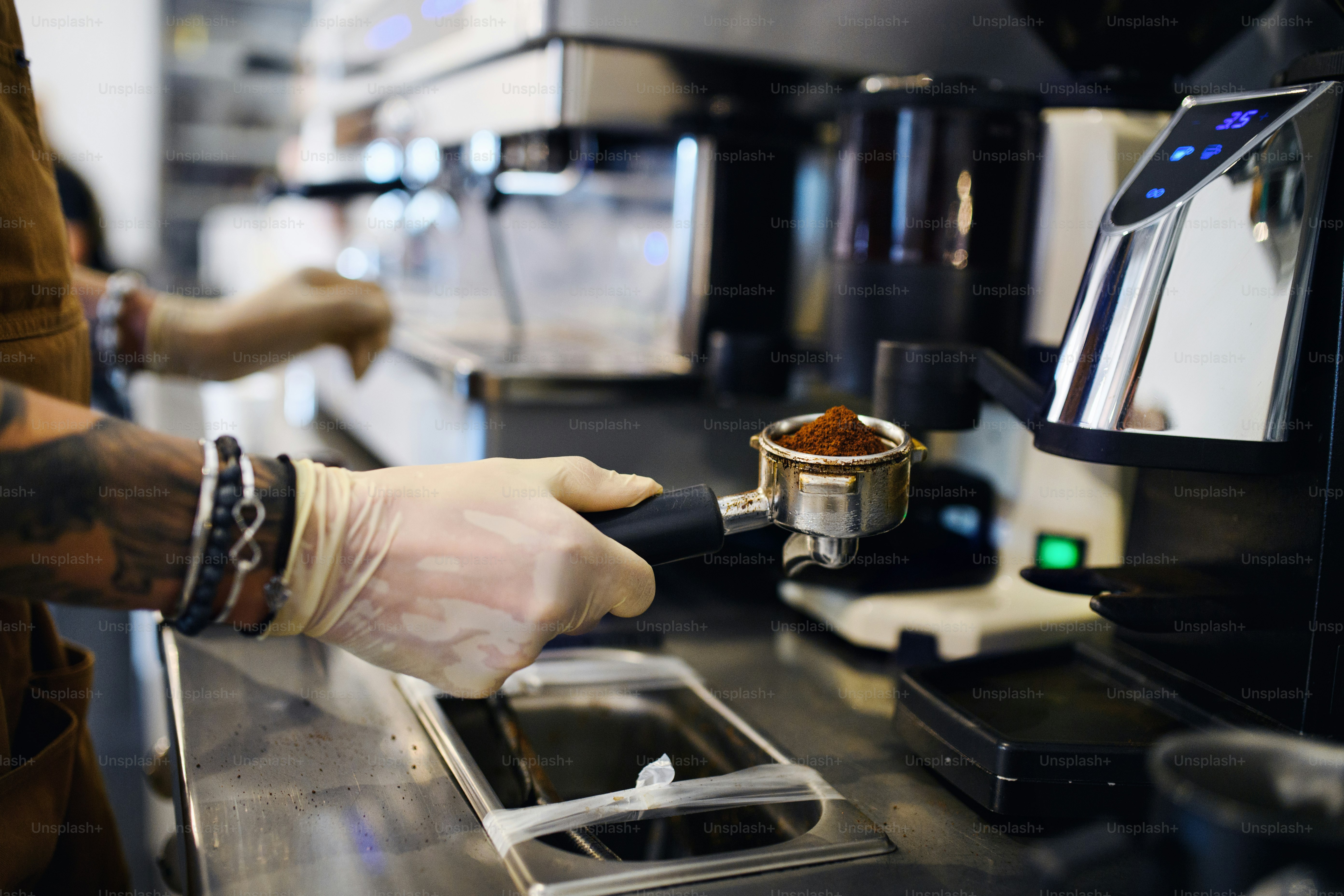 Unrecognizable barista working with gloves, coffee shop open after ...
