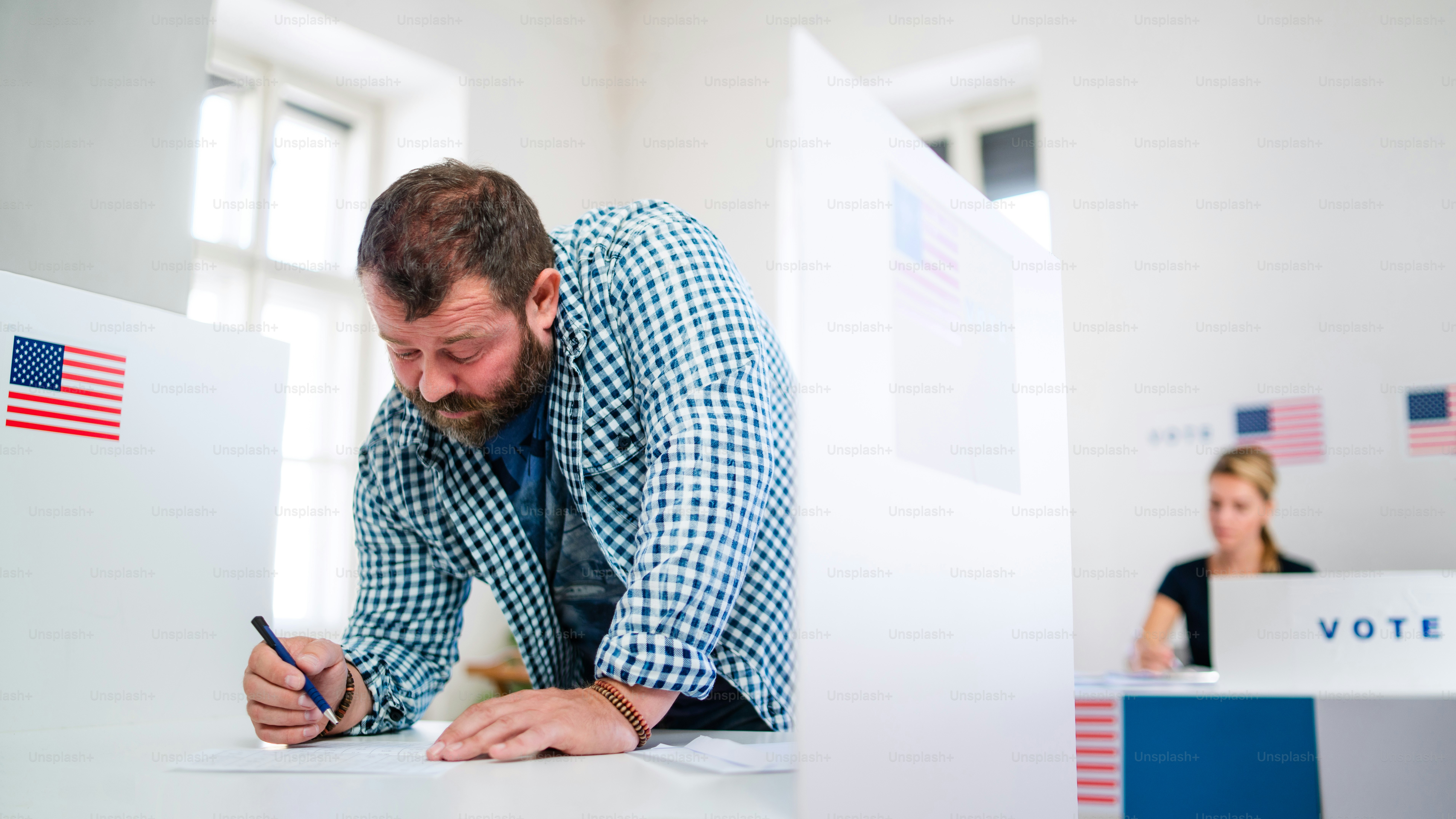 Front view portrait of man voter in polling place, usa elections ...