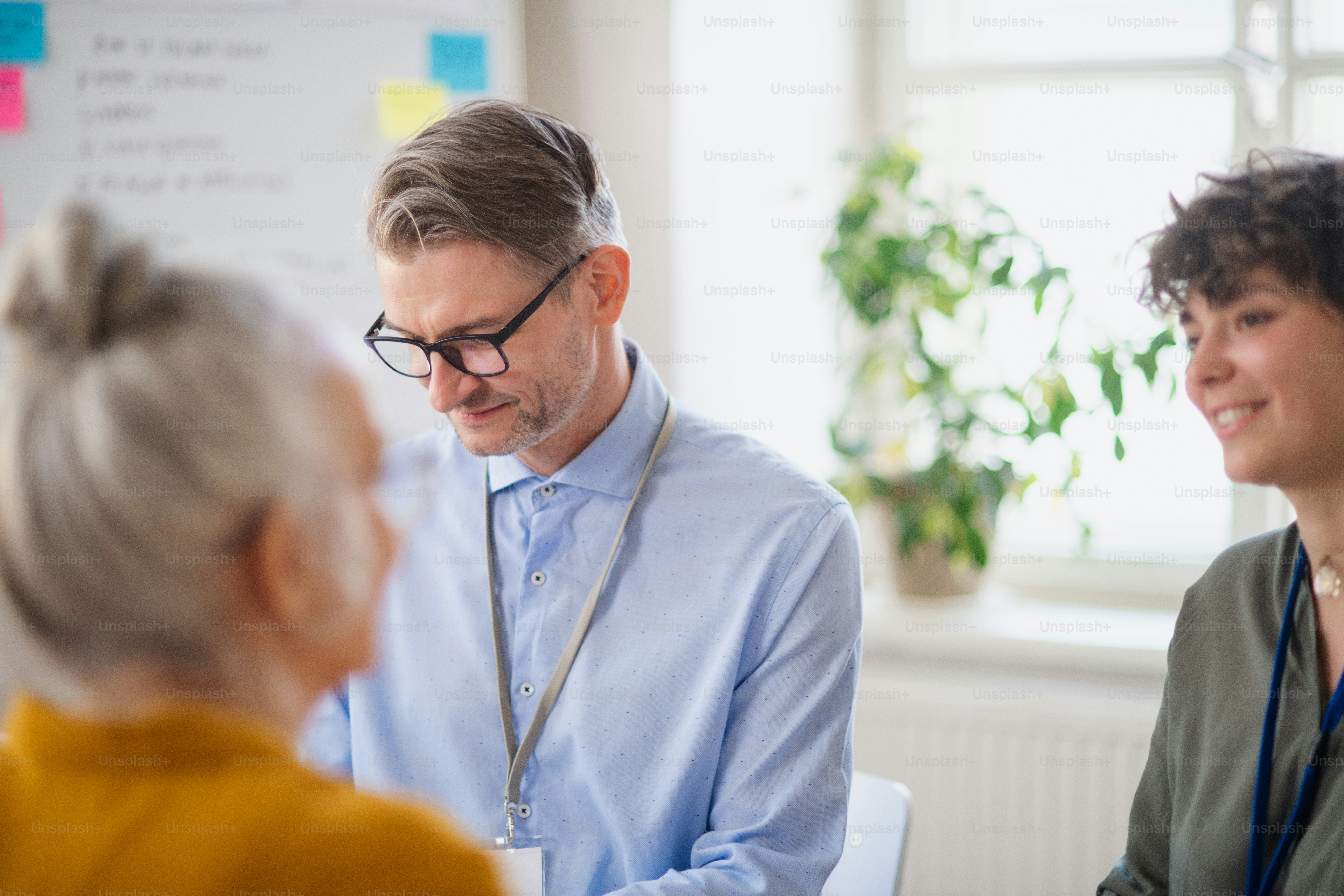A Rear view of senior woman at job interview. photo – Business Image on ...