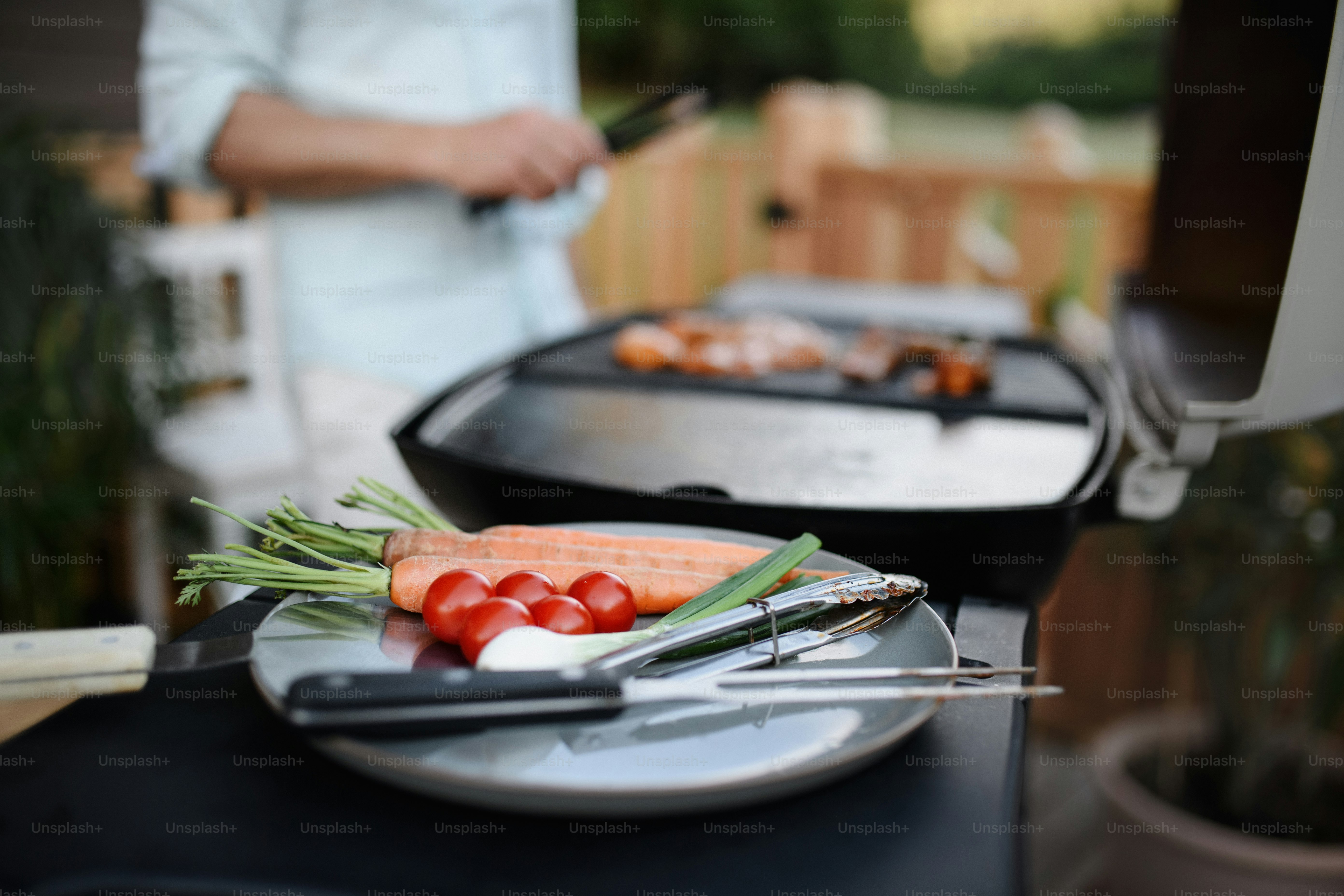 Vegetables on a plate prepared for grilling during weekend barbecue in ...