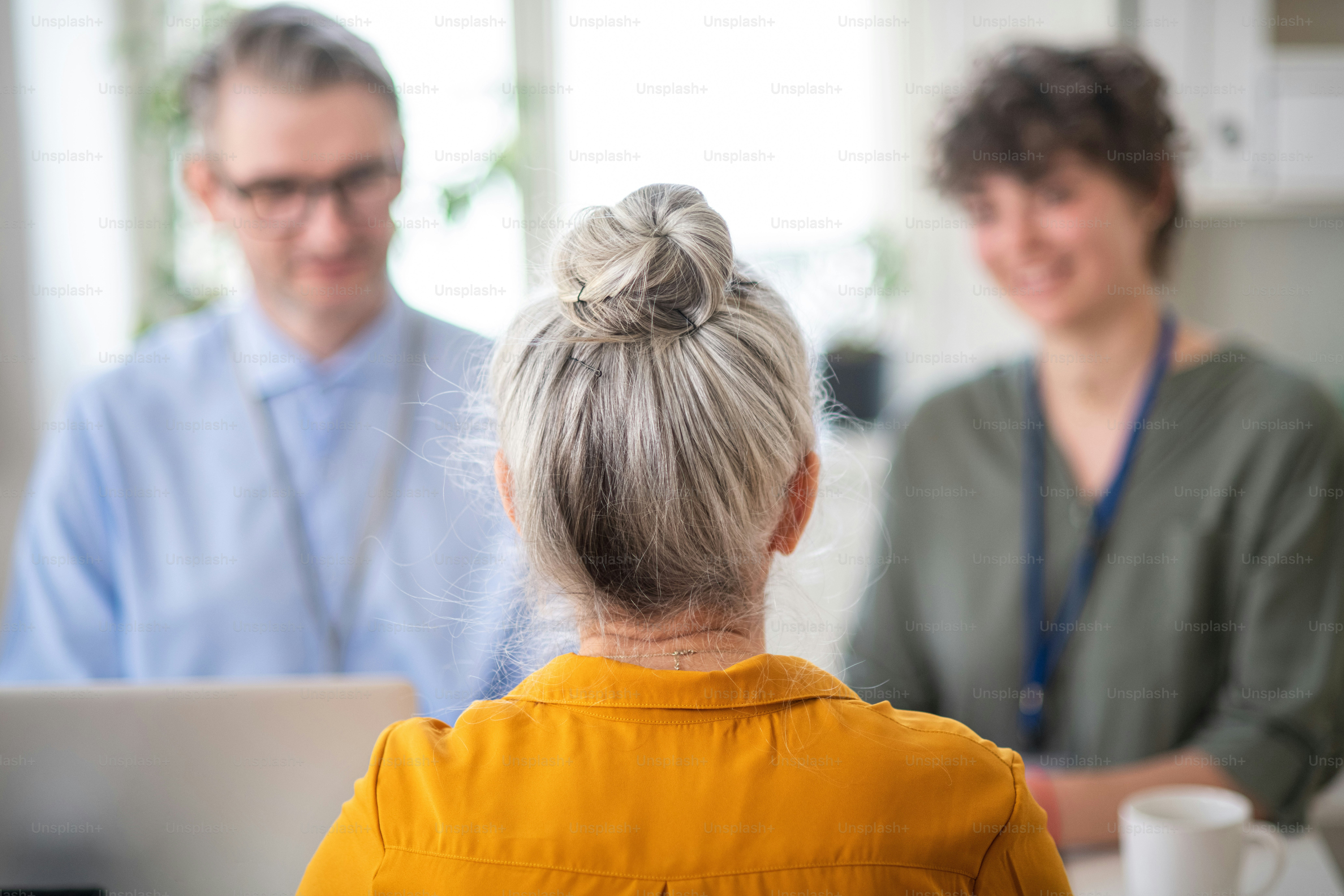 A Rear view of senior woman at job interview. photo – Job search Image ...