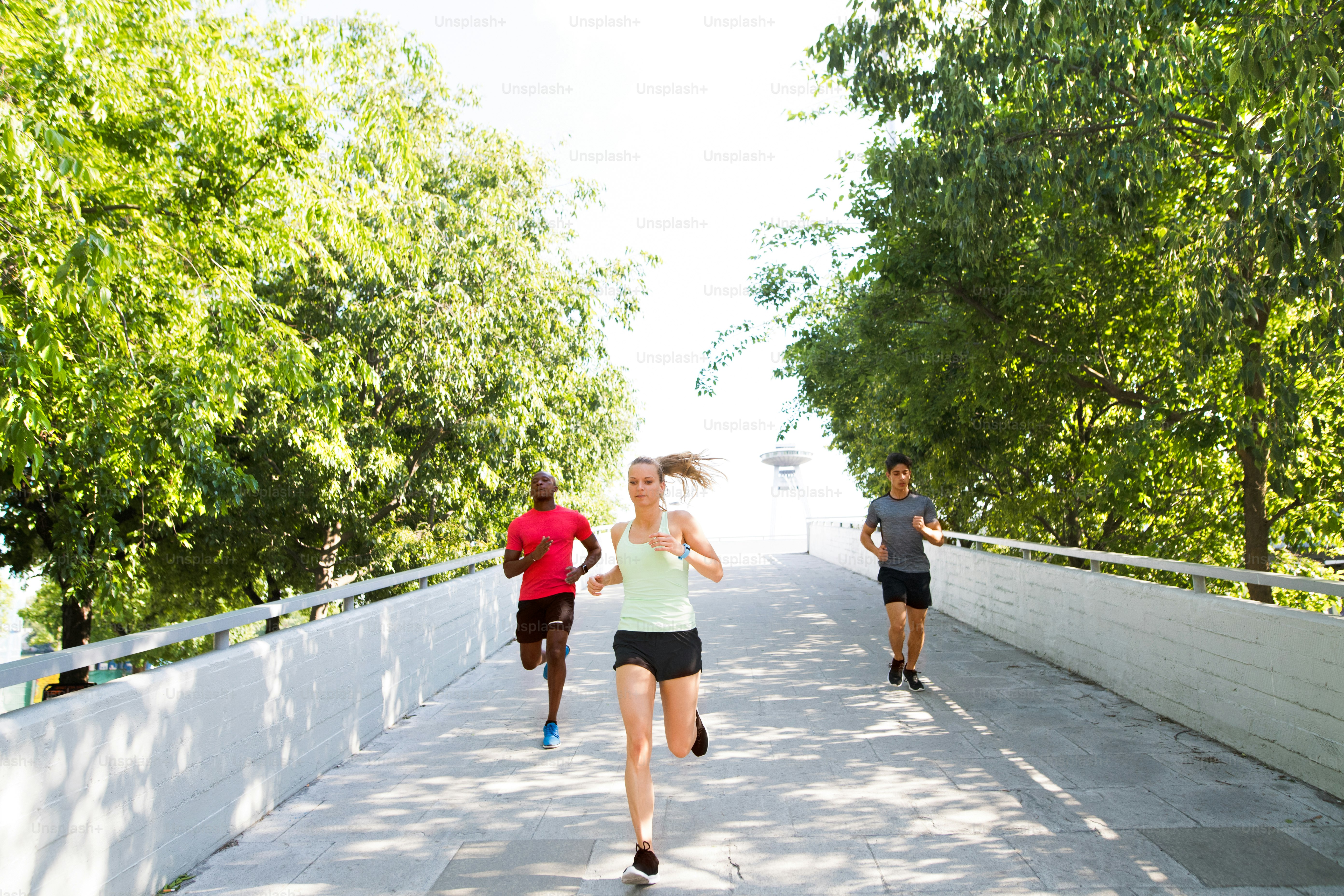 Beautiful young people in the city running together. photo – Sport ...