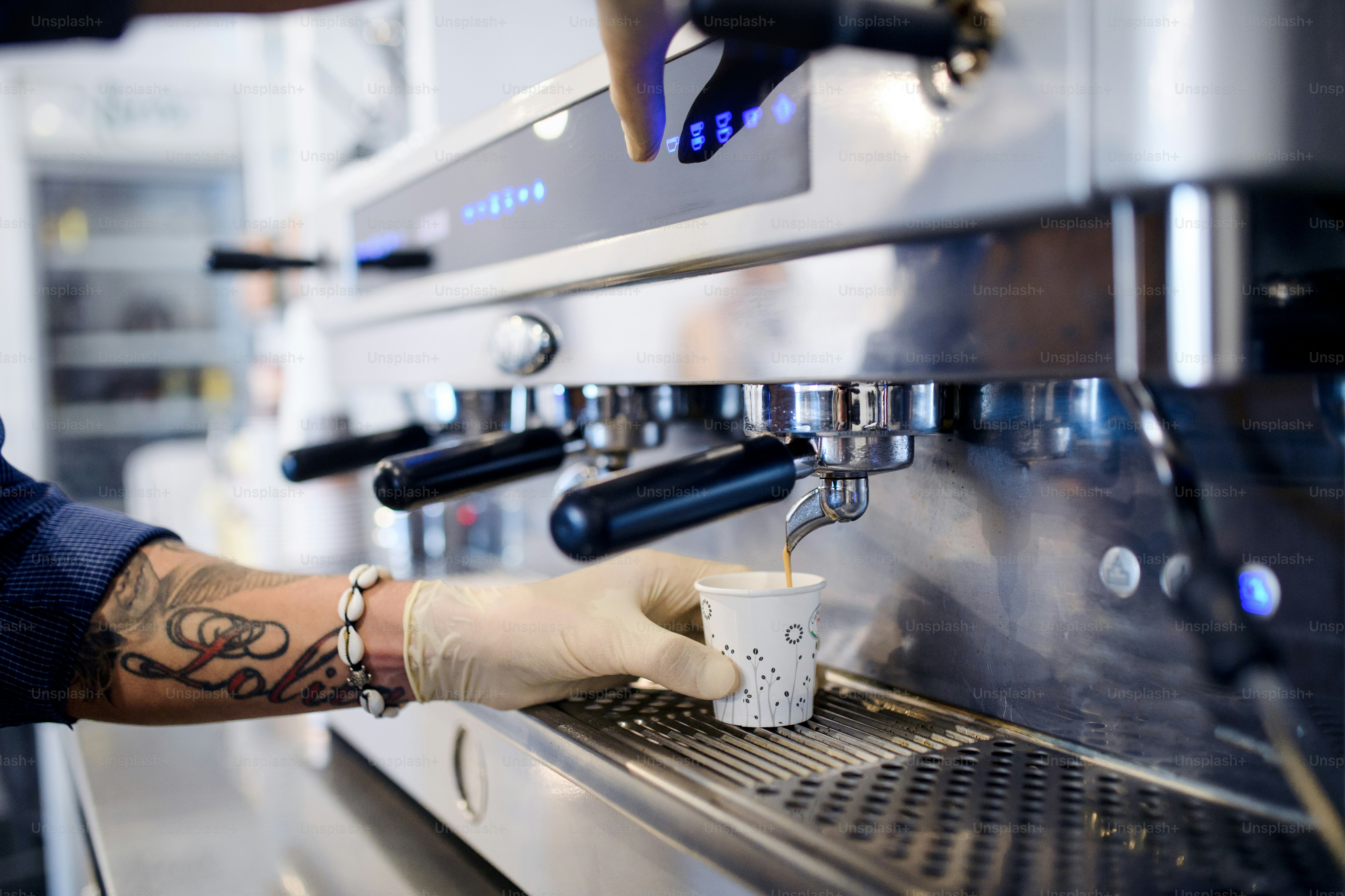Unrecognizable barista working with gloves, coffee shop open after ...