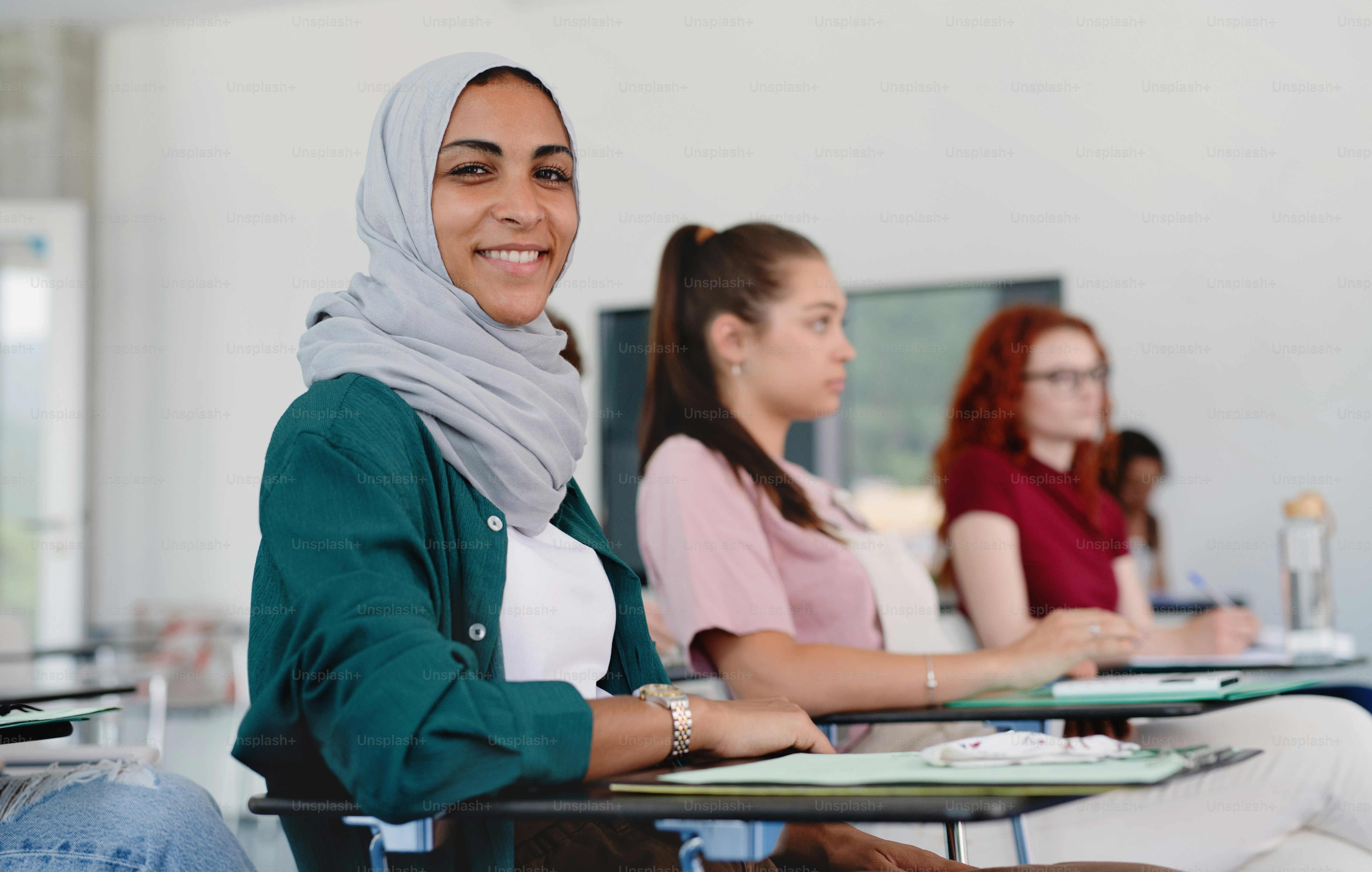 A portrait of islamic university student sitting in classroom indoors ...