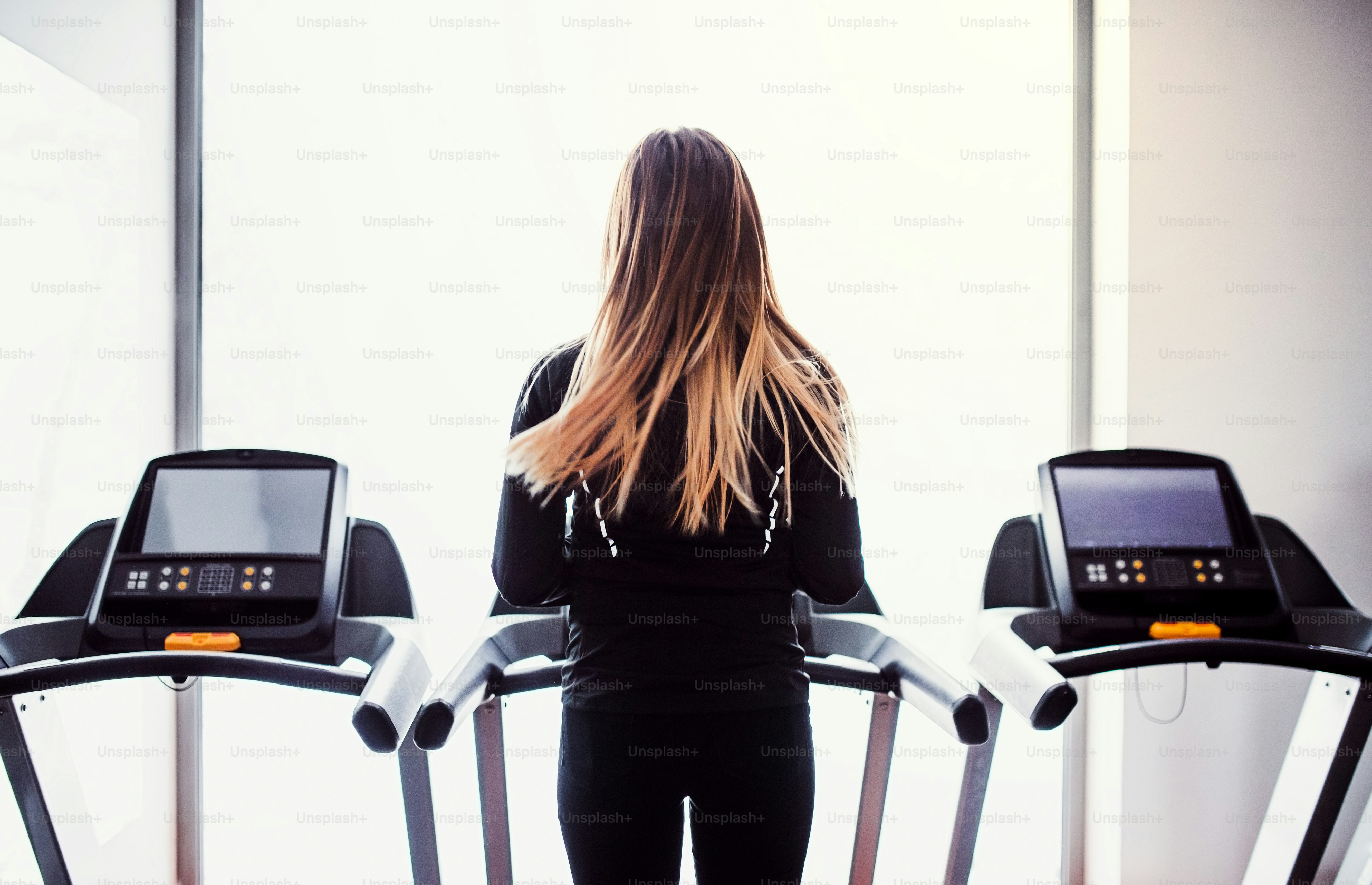 A front view of a beautiful young girl or woman doing strength workout ...