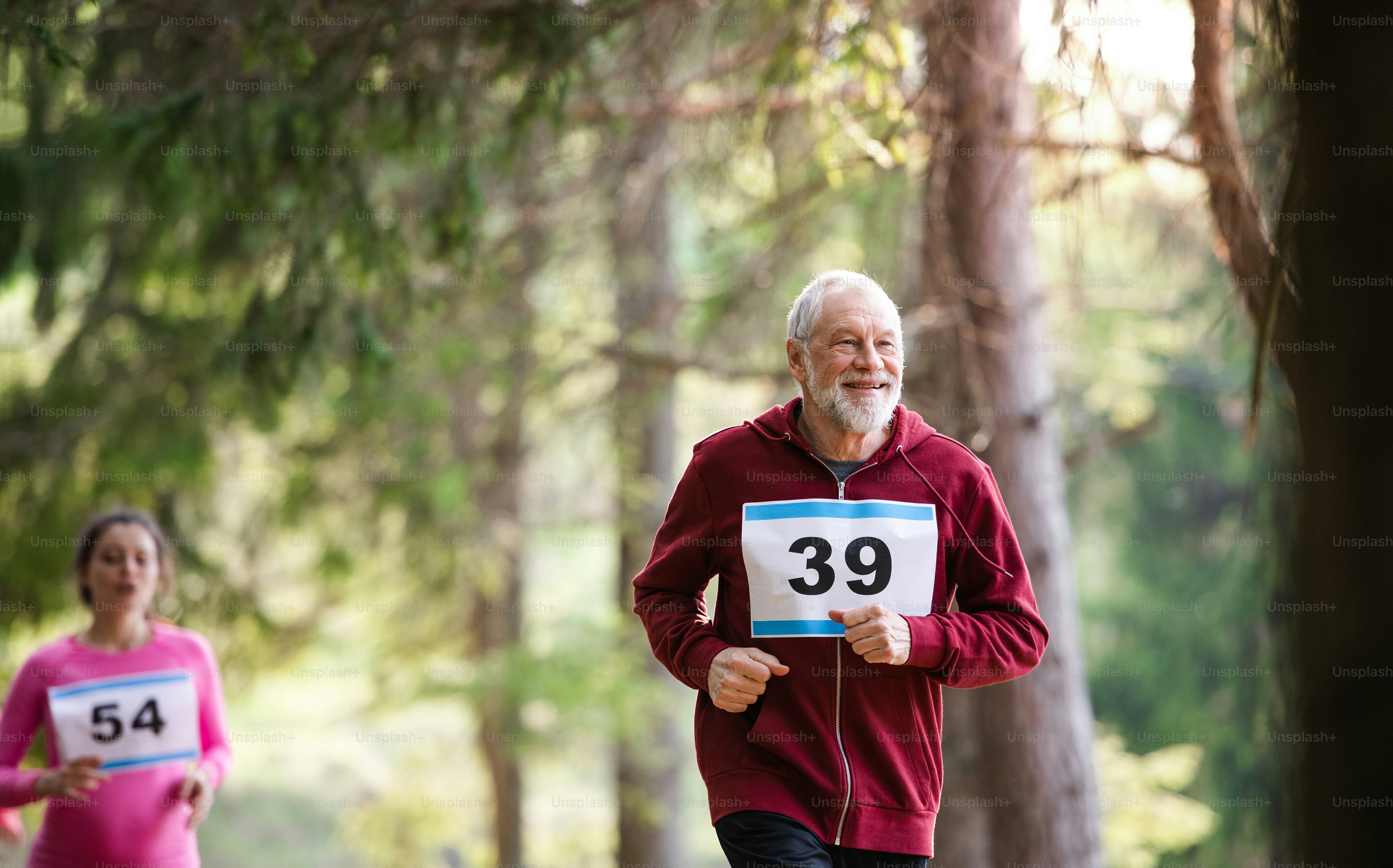 A group of active people running a race competition in nature. photo ...