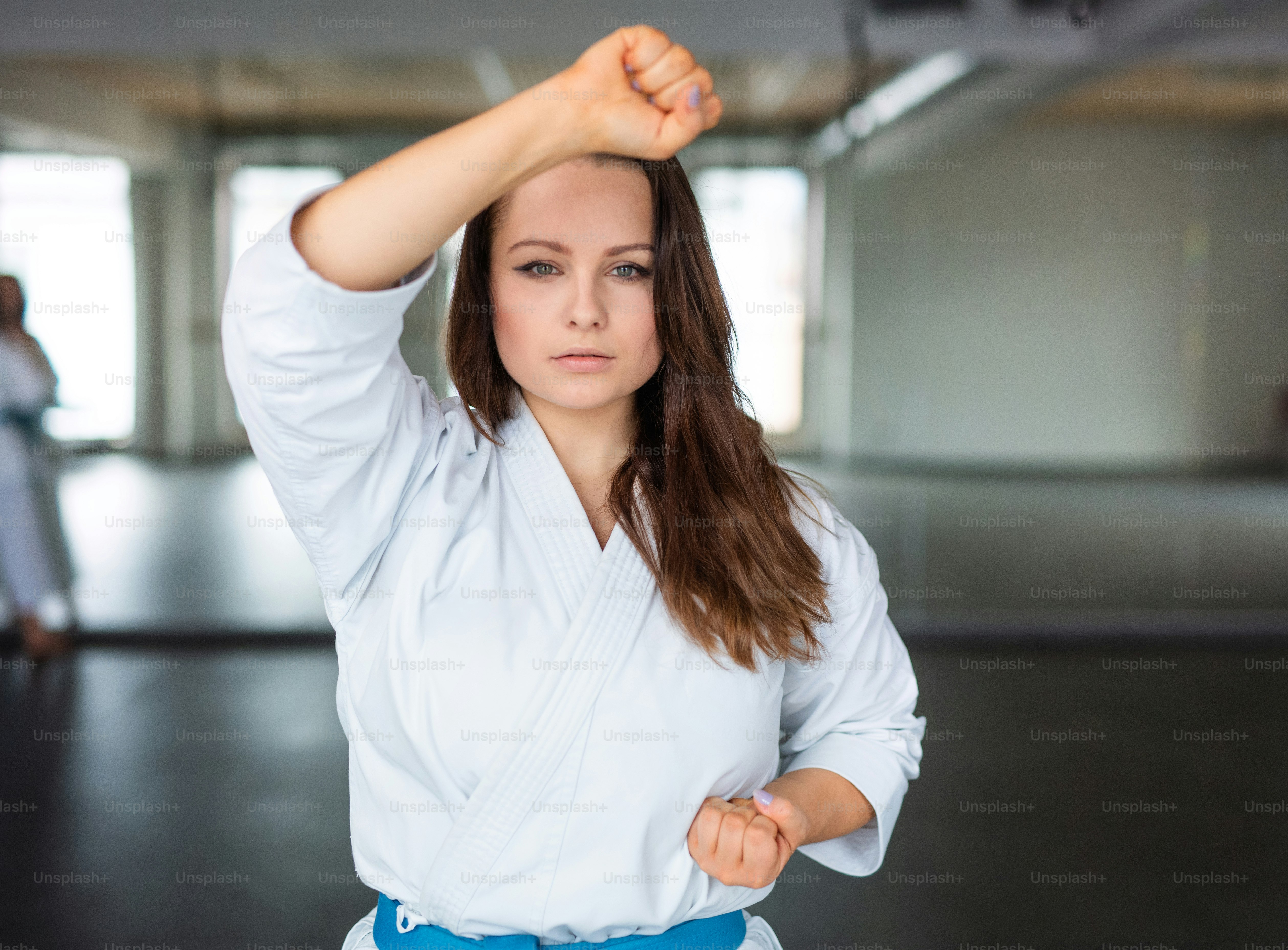 An attractive young woman practising karate indoors in gym. photo ...