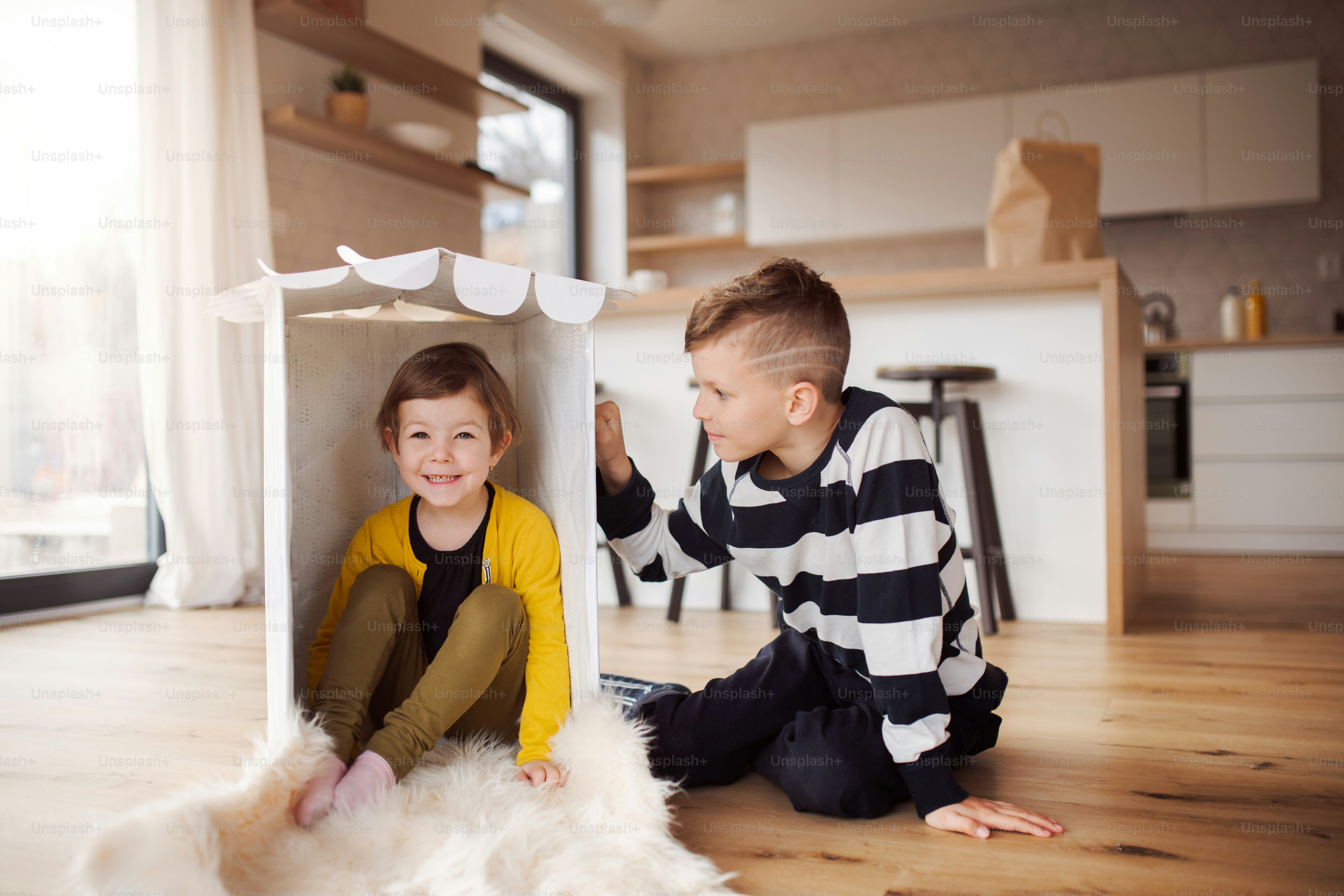 Two happy small children playing indoors at home. photo – Mother and ...