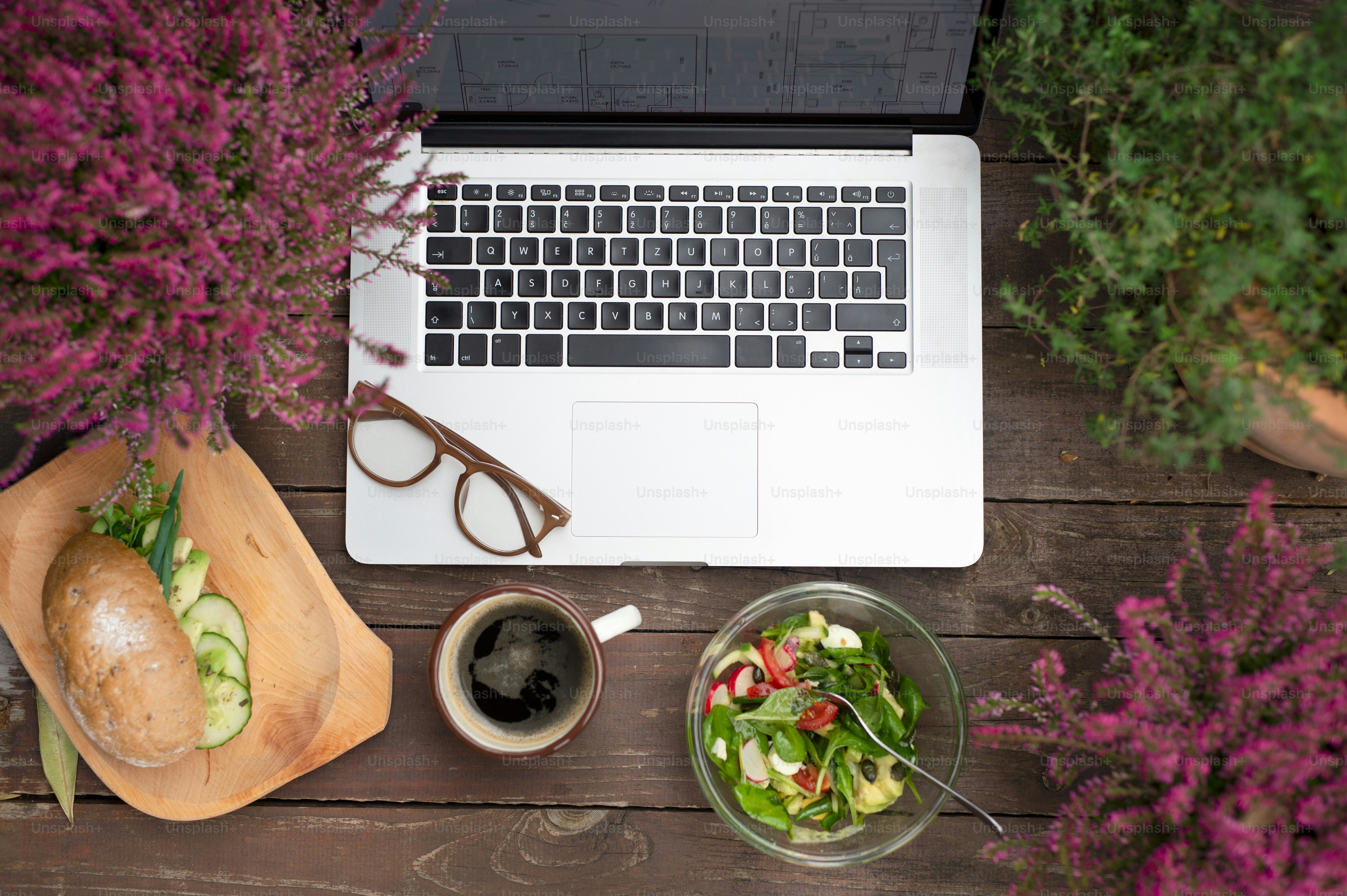 A composition of laptop and lunch on bench outdoors on terrace. photo ...
