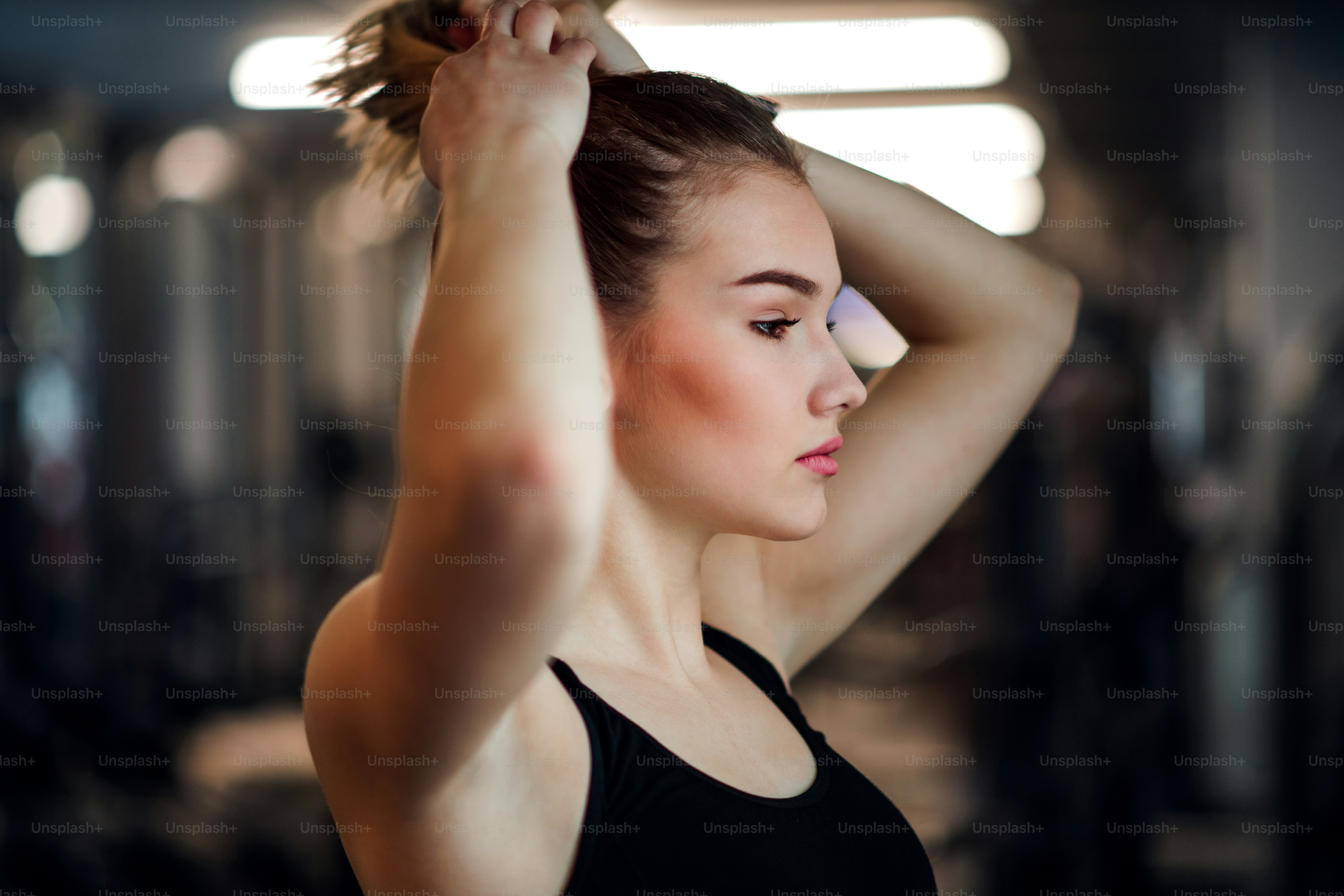 Un portrait d’une belle jeune fille ou d’une belle femme debout dans un gymnase. photo ...