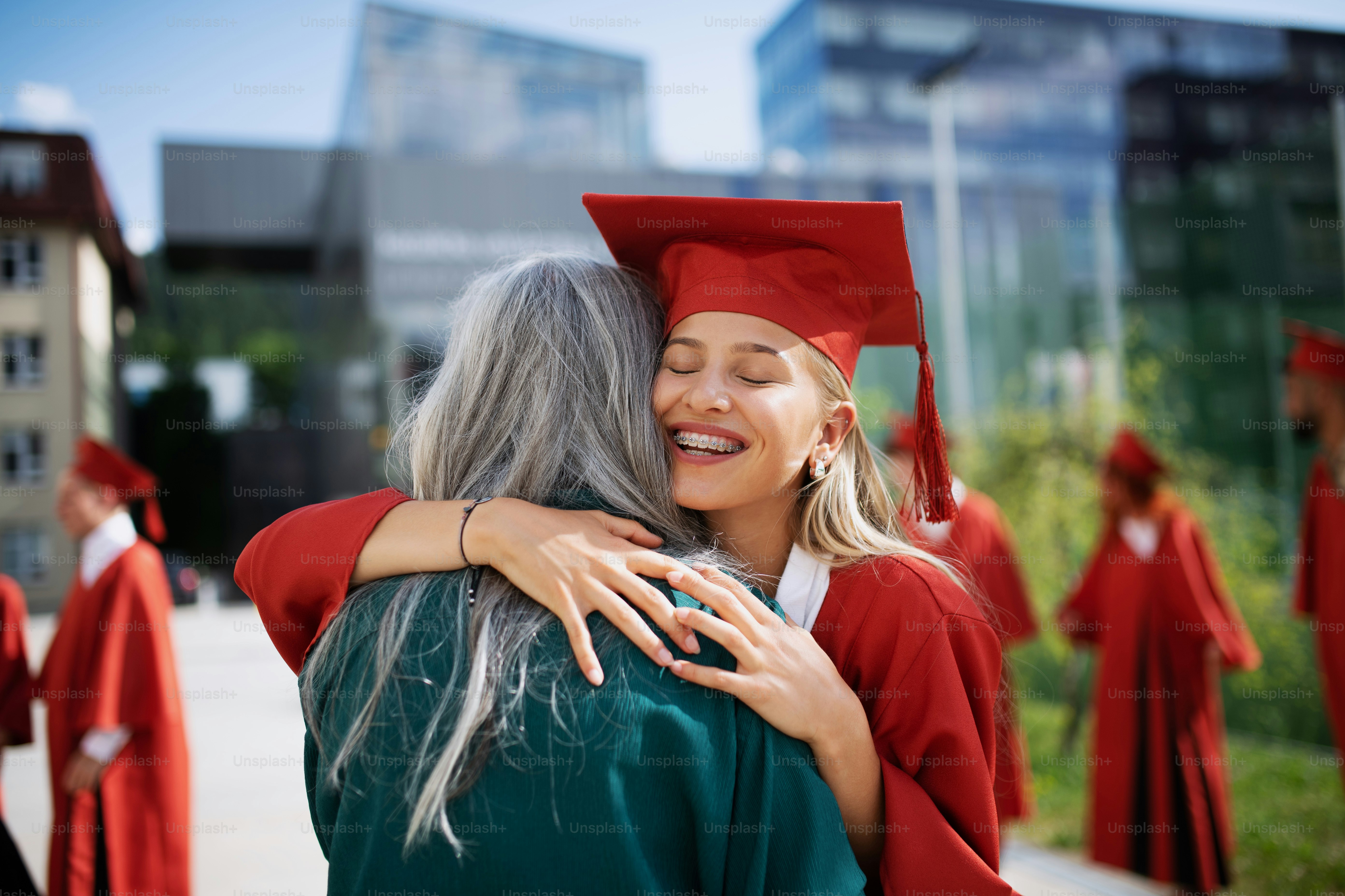 A portrait of cheerful university student celebrating outdoors ...