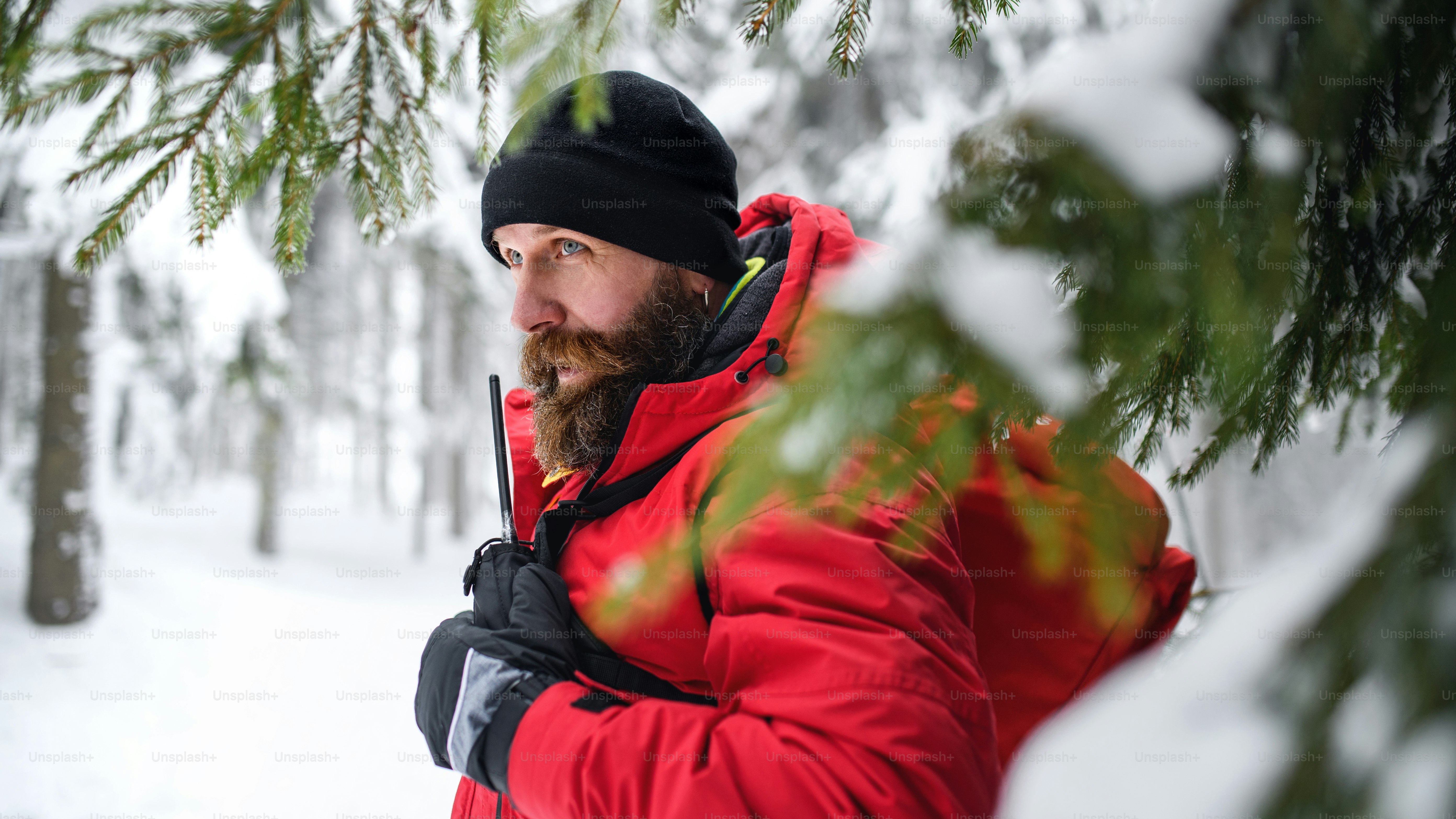 Paramedic man from mountain rescue service with walkie talkie outdoors ...