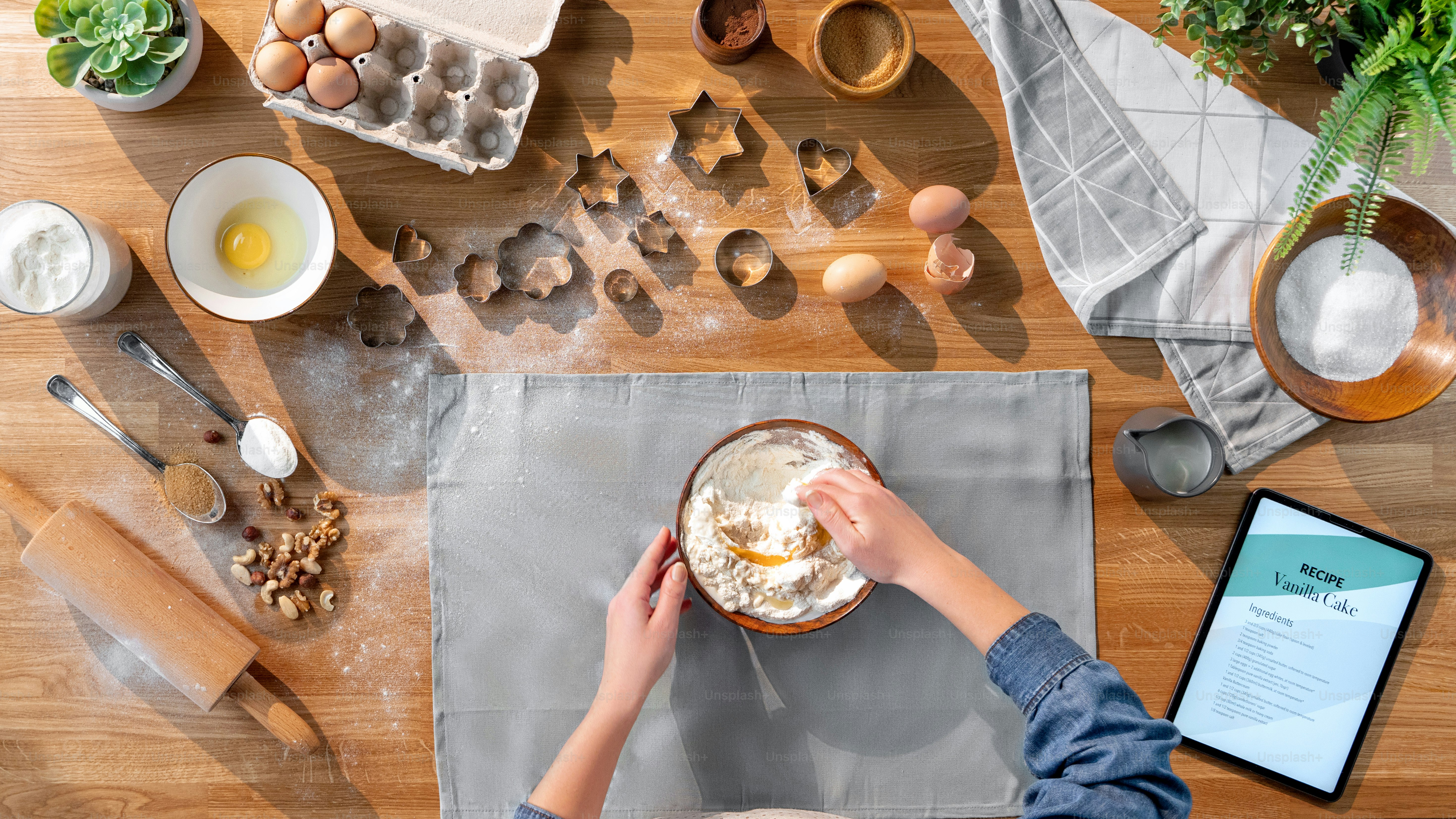 A top view of unrecognizable woman baking biscuits, desktop concept ...