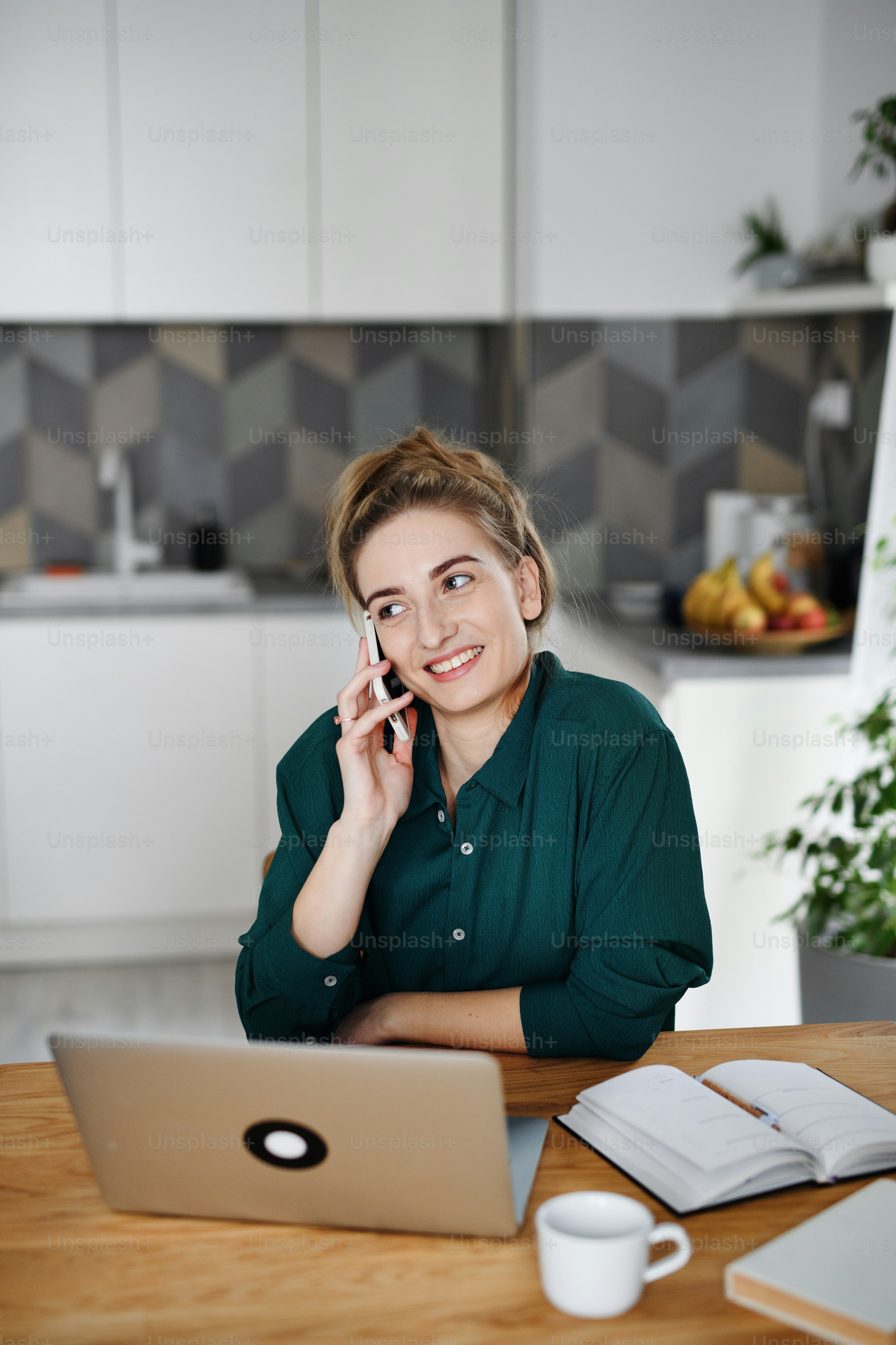A young woman student with laptop and smartphone at home, home office ...
